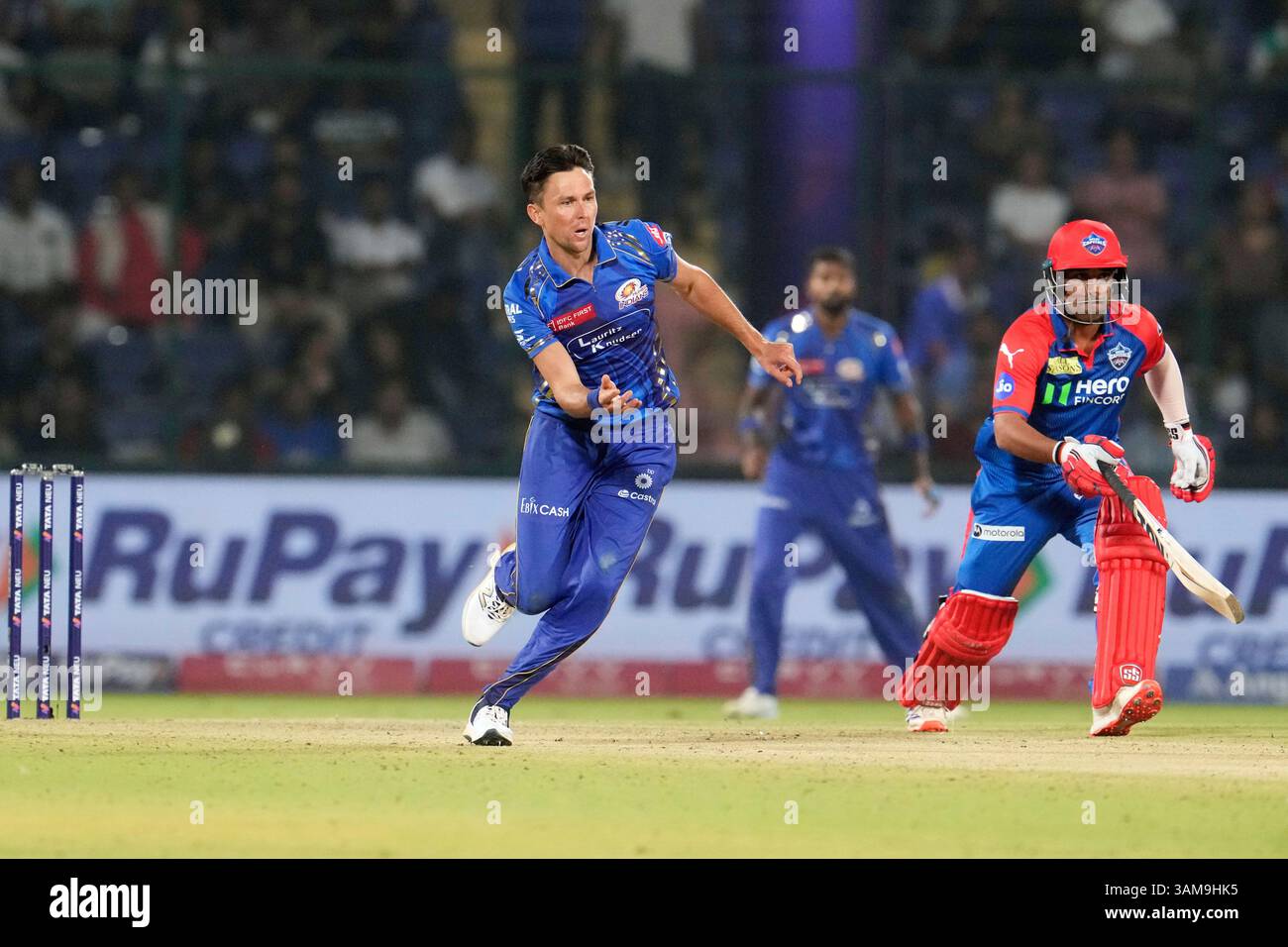 Mumbai Indians' Trent Boult, left, runs to field the ball during the ...