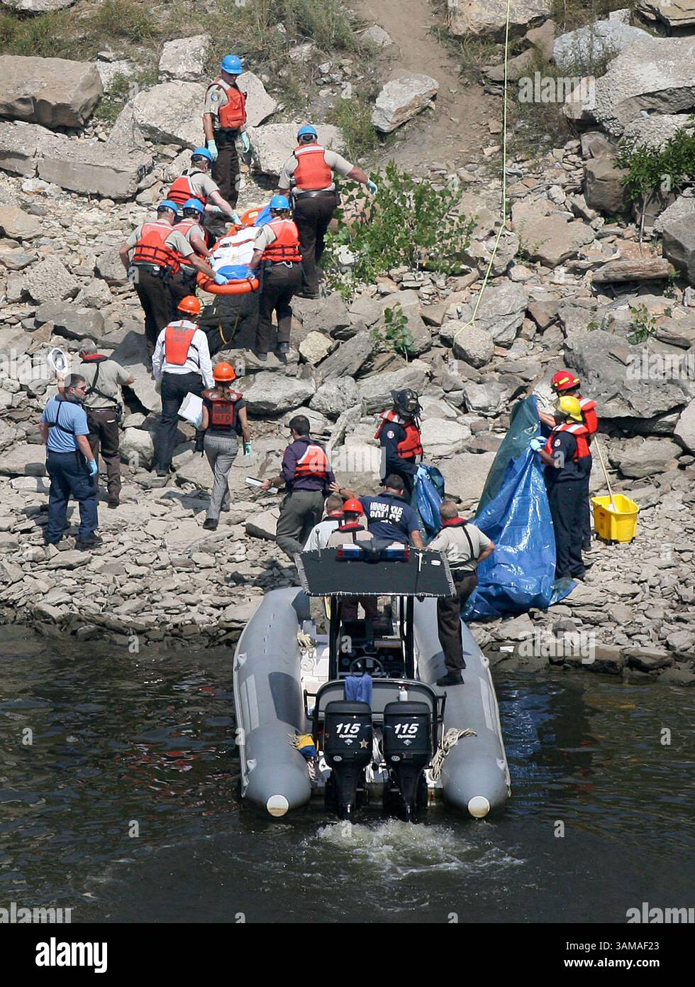 Aug. 11, 2007 - STAMP, U.S. - Officials carry a body from the I-35W ...