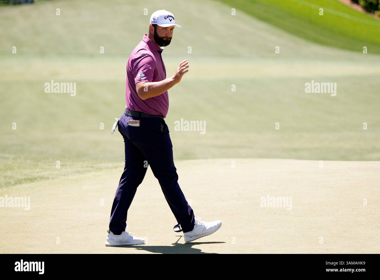 Jon Rahm, of Spain, waves after making a putt on the sixth hole during ...