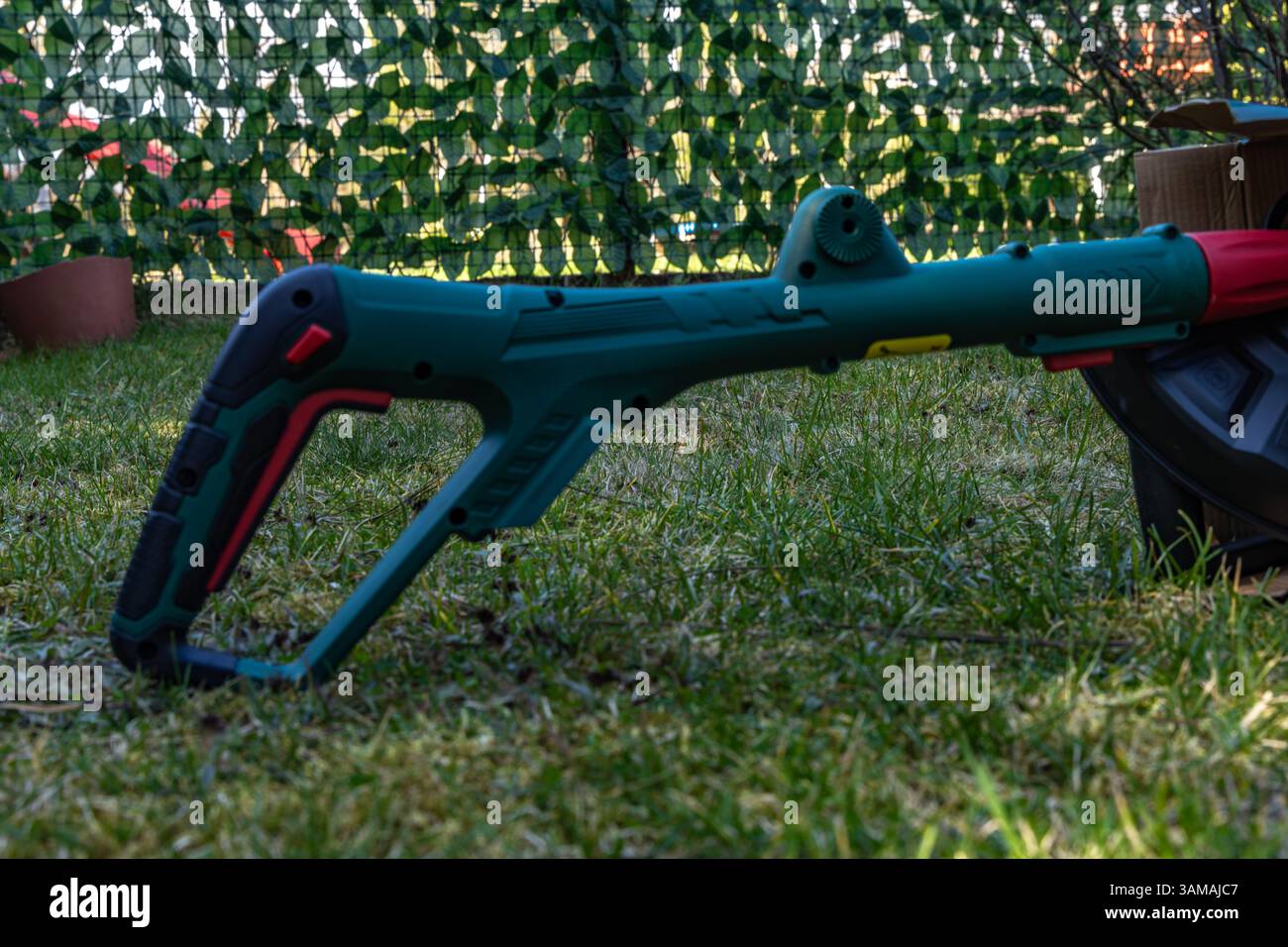 Battery-powered lawn mower, cordless trimmer placed on the lawn, new ...