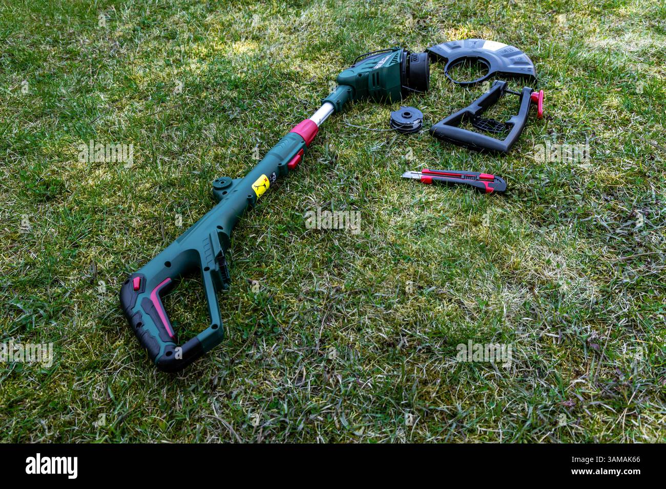 Battery-powered lawn mower, cordless trimmer placed on the lawn, new ...