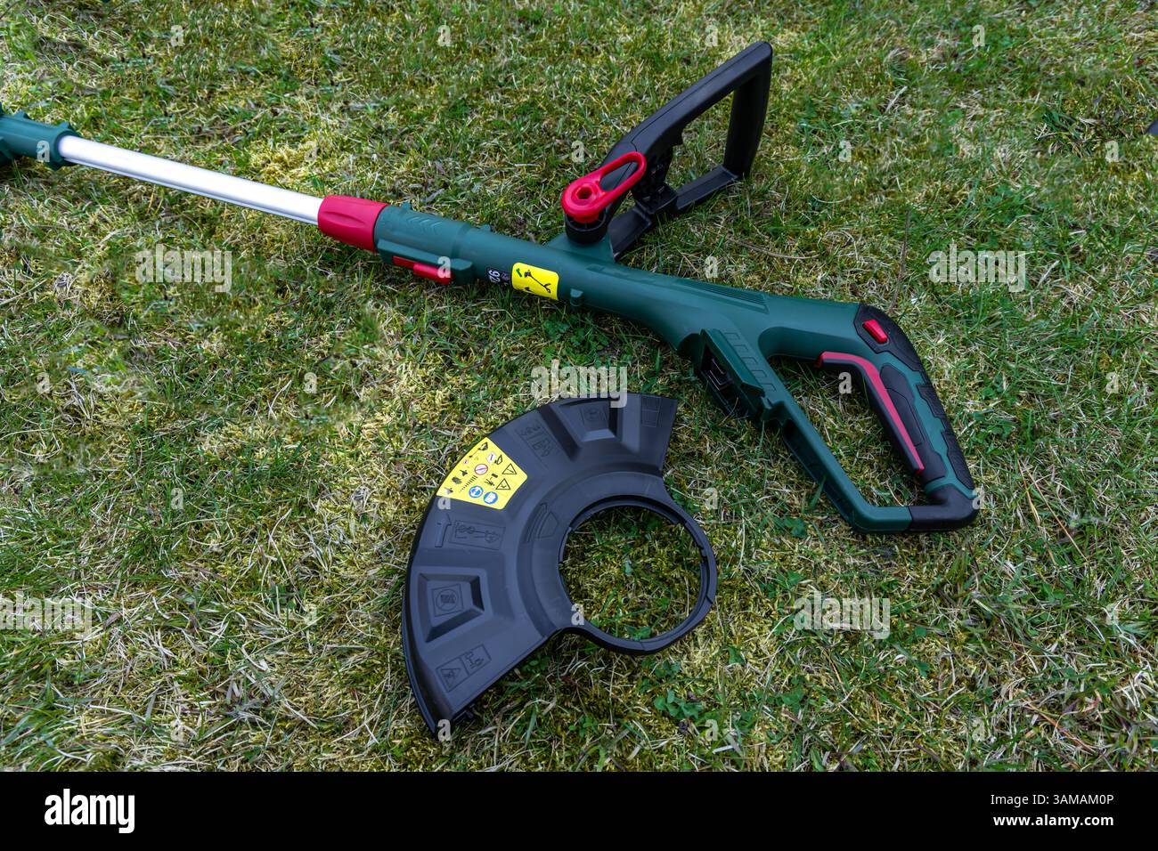 Battery-powered lawn mower, cordless trimmer placed on the lawn, new ...