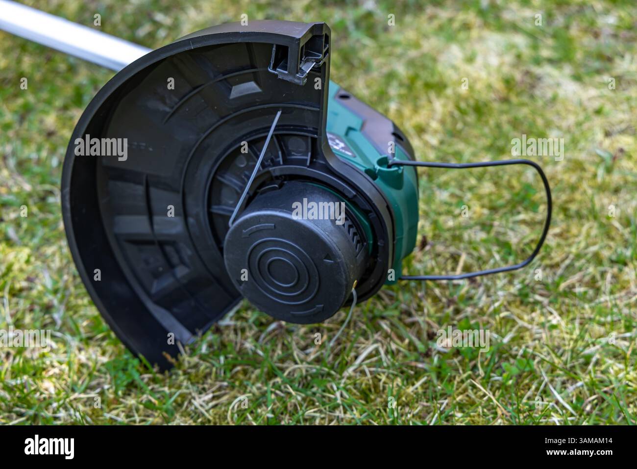 Battery-powered lawn mower, cordless trimmer placed on the lawn, new ...
