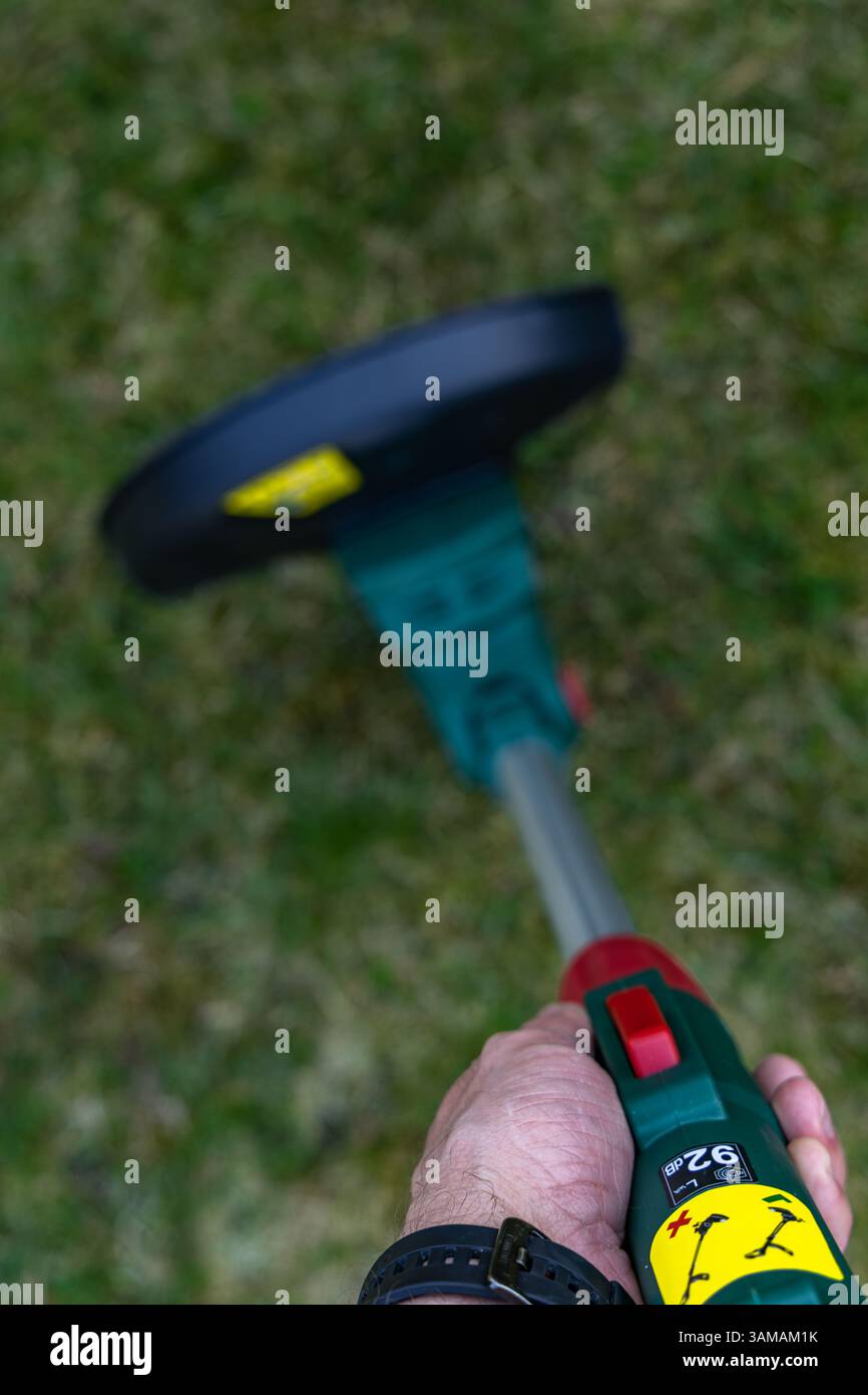 Battery-powered lawn mower, cordless trimmer placed on the lawn, new ...