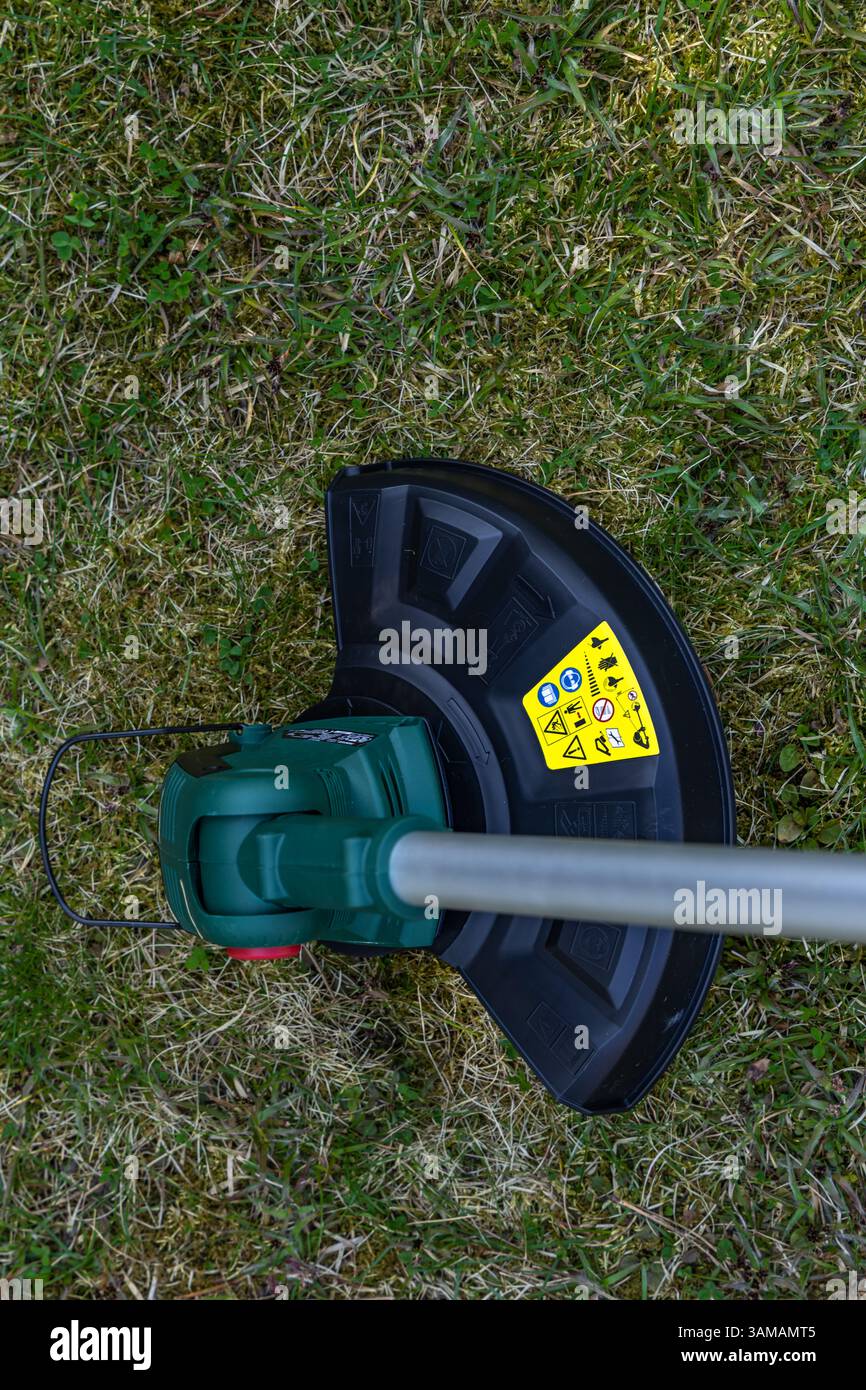 Battery-powered lawn mower, cordless trimmer placed on the lawn, new ...