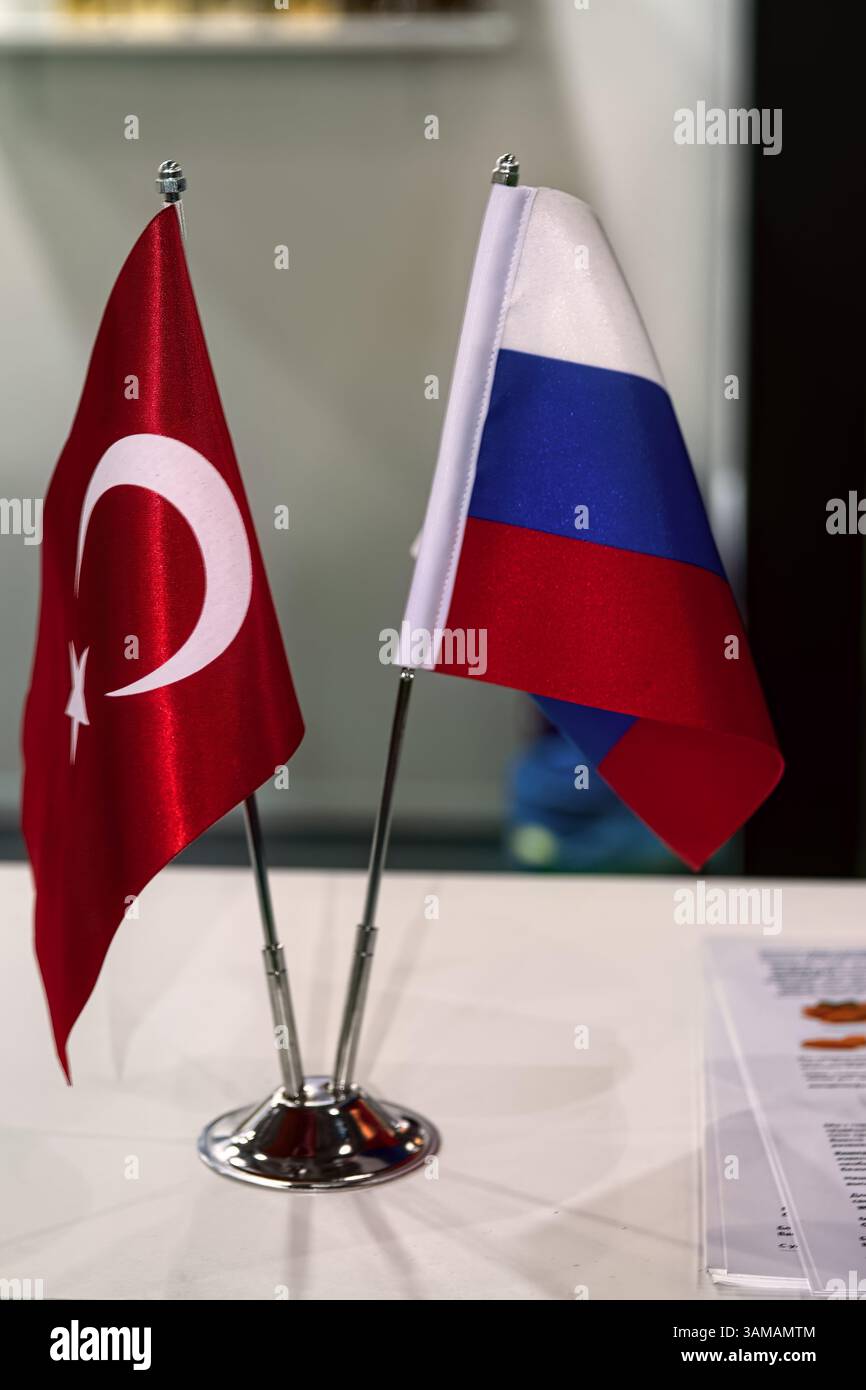 Russian and Turkish flags on table in meeting room. The concept of ...