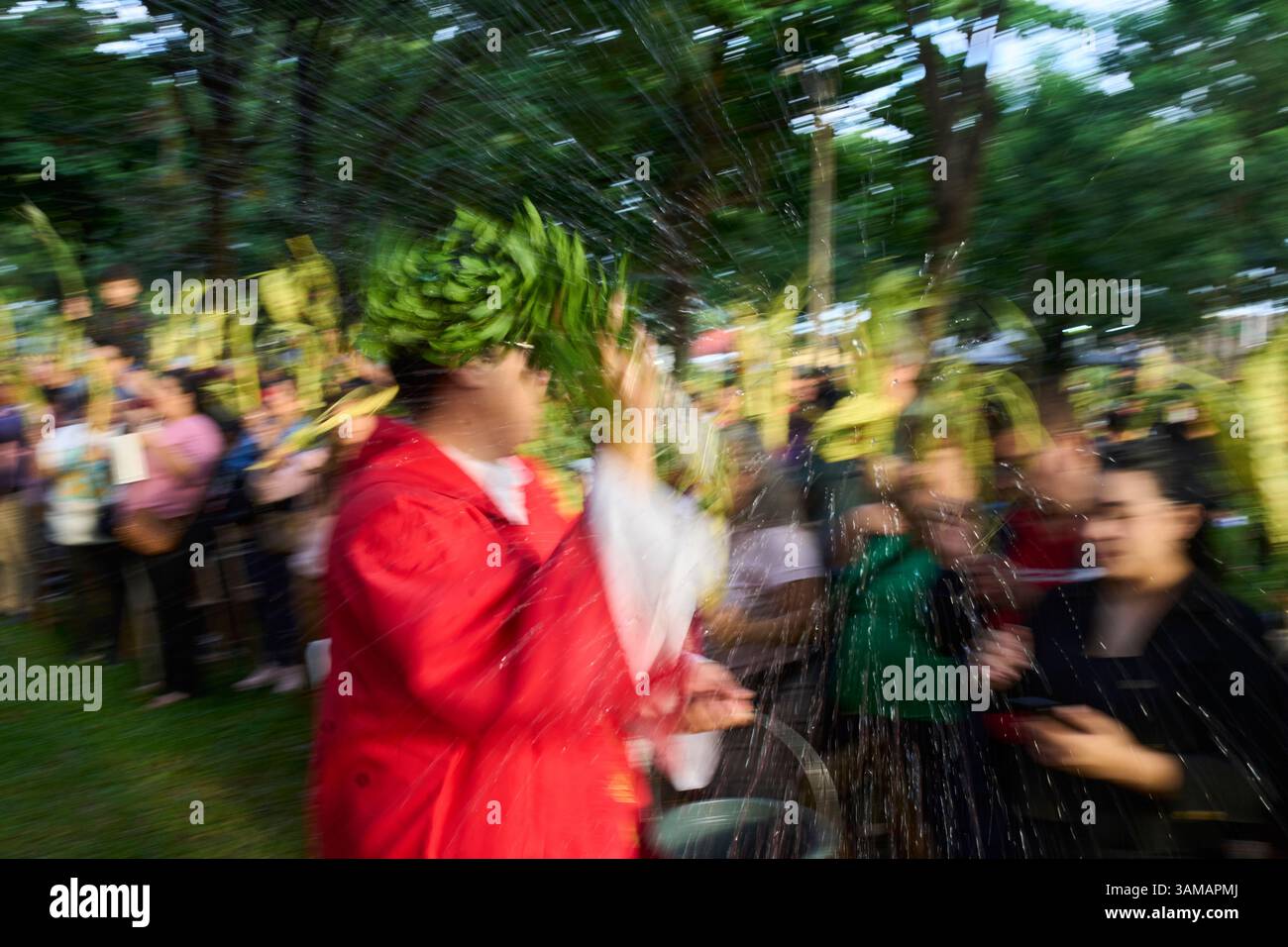 A priest blesses people with water before a Palm Sunday Mass at the ...
