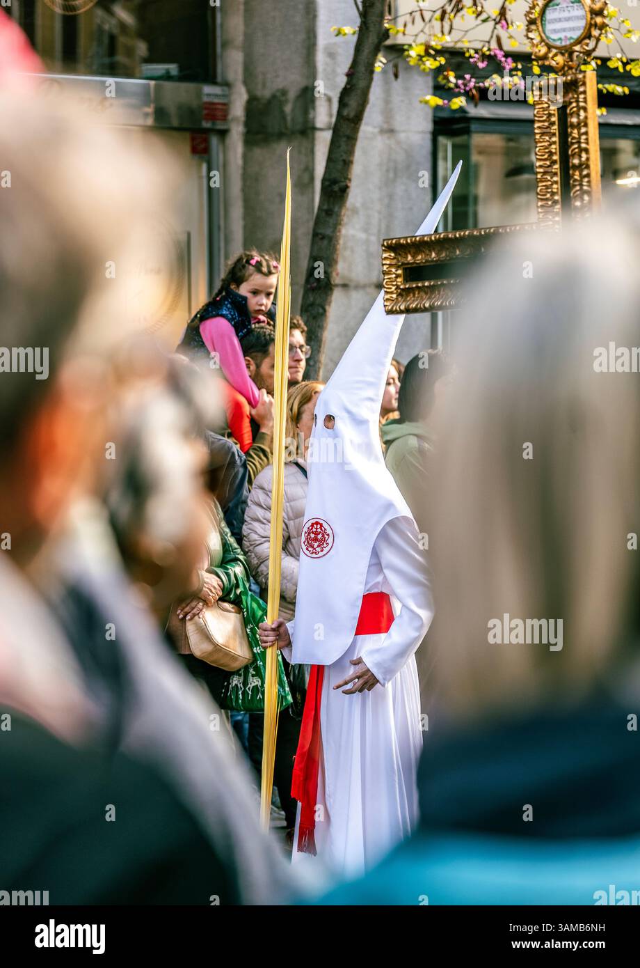 A Nazareno figure participates in a Holy Week procession in Madrid ...