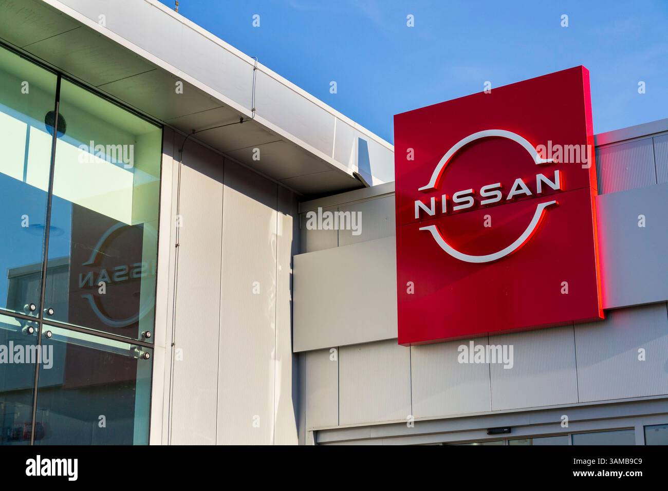 Nissan motor company logo on dealership building on April 12, 2025 in ...