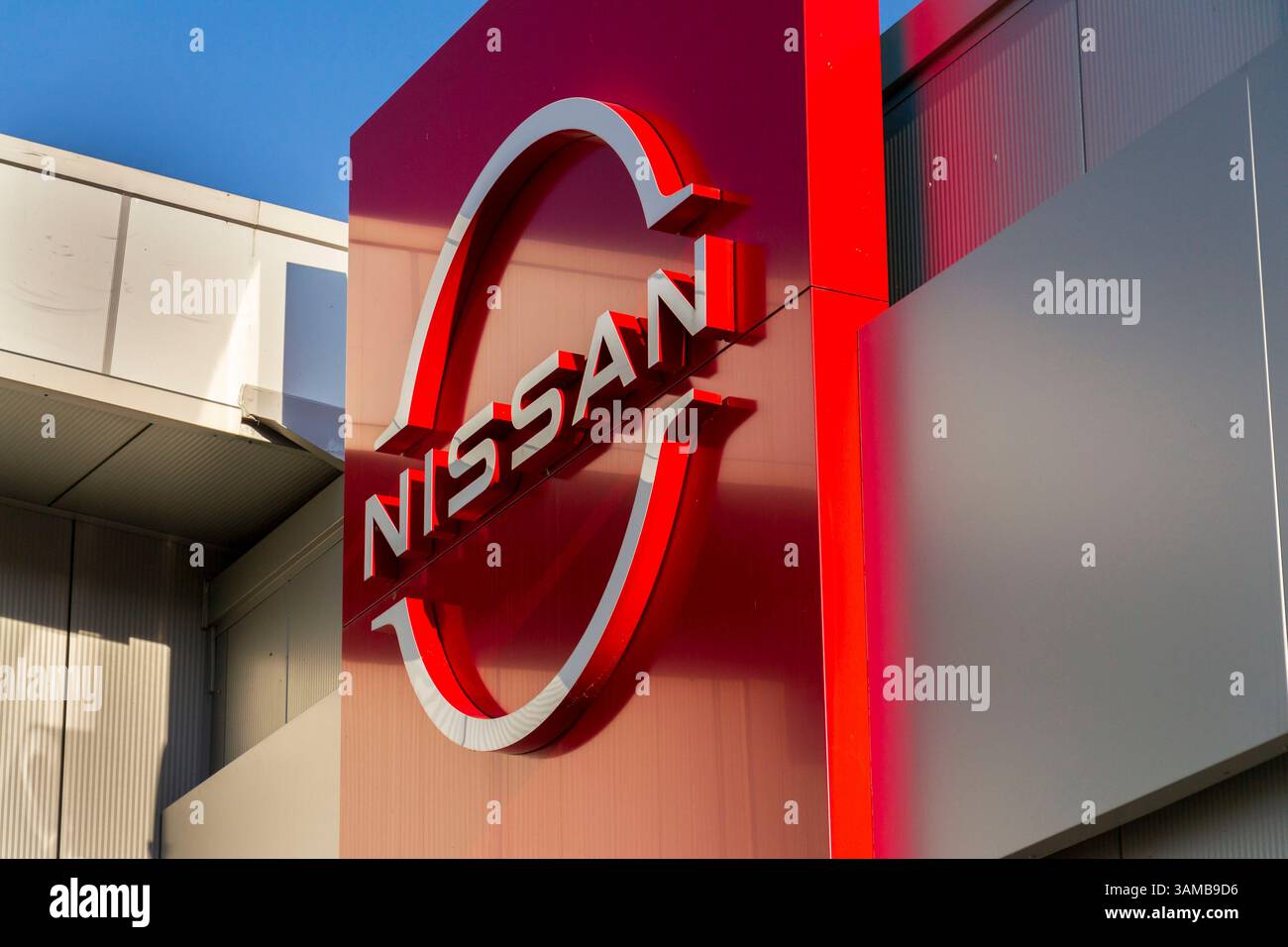 Nissan motor company logo on dealership building on April 12, 2025 in ...