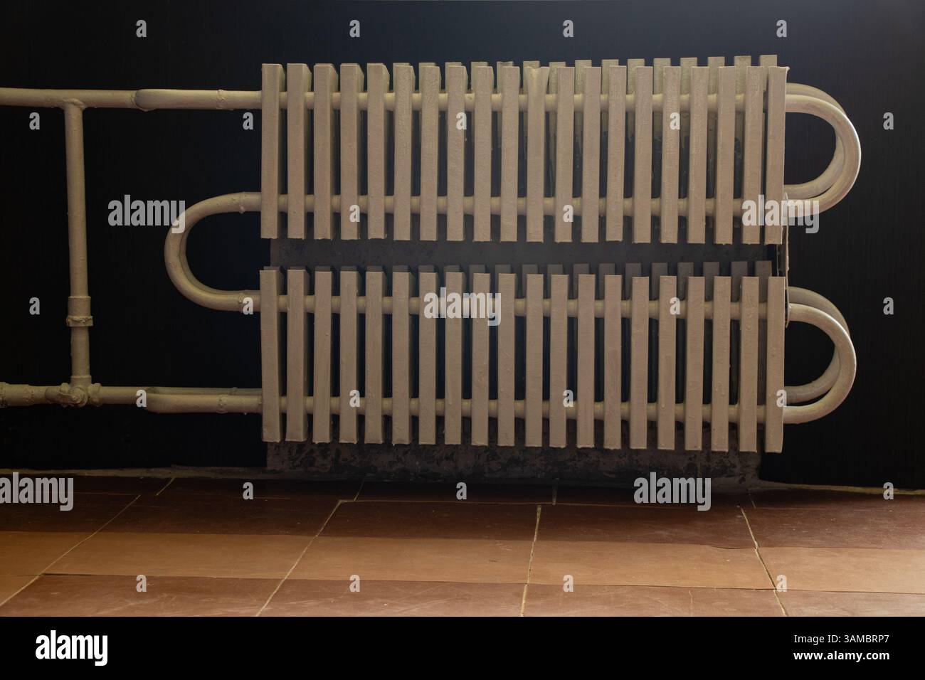 White old radiator in the apartment under the window in the bedroom ...