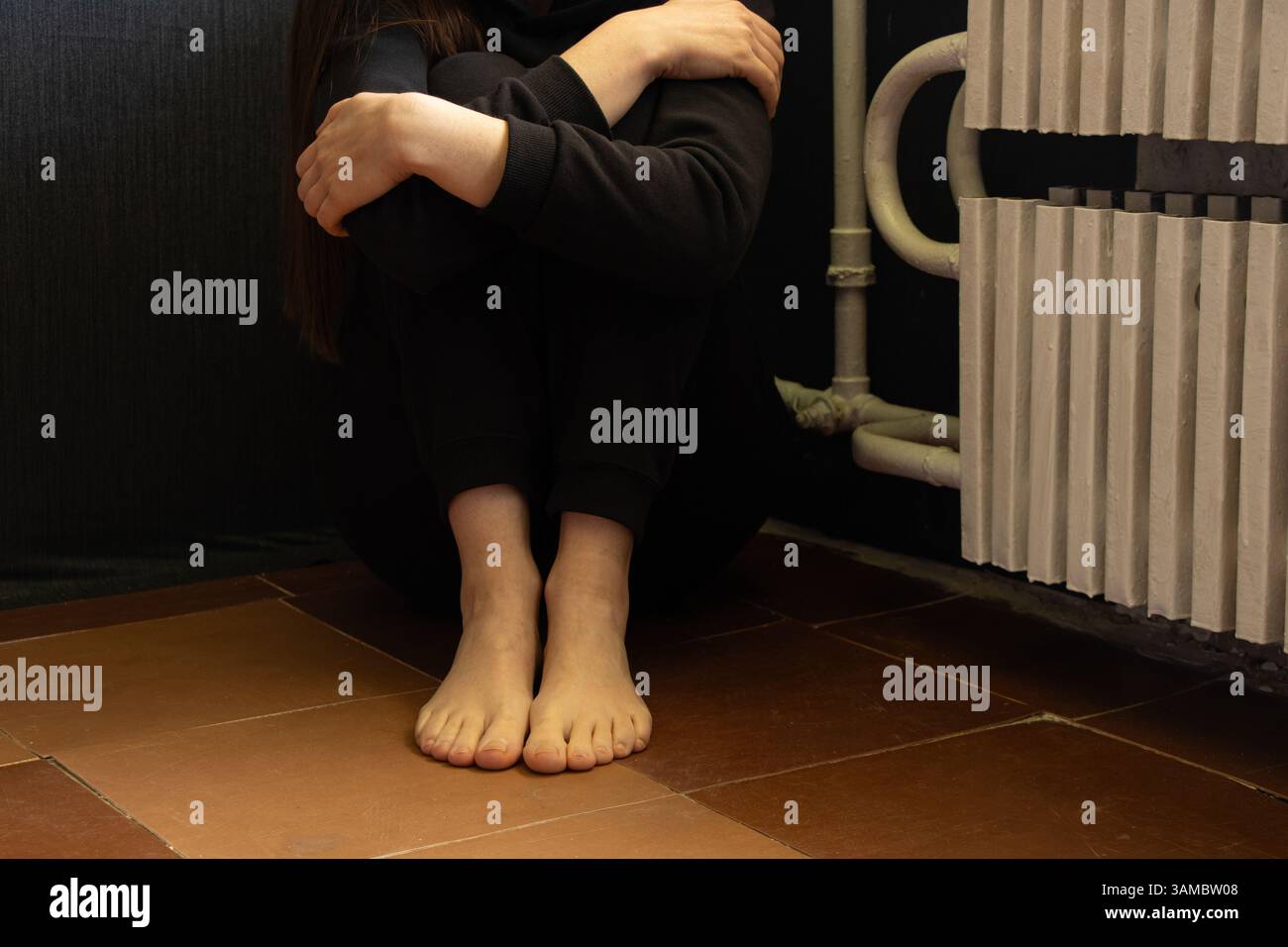 A white old radiator in an apartment under a window in the bedroom and ...