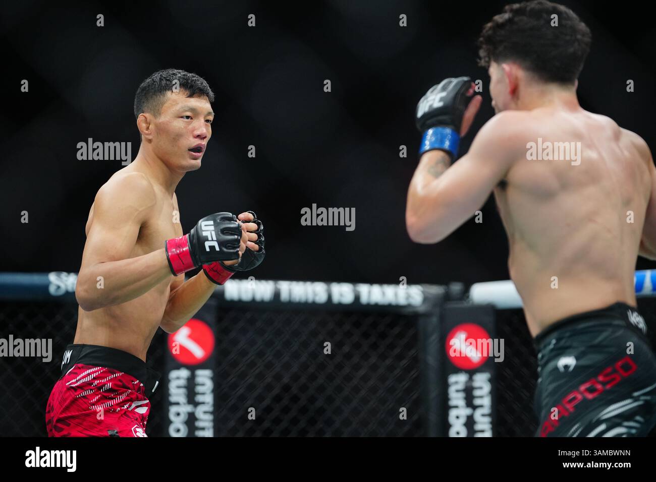 MIAMI, FL - APRIL 12:Sumudaerji and Mitch Raposo meet in the octagon ...