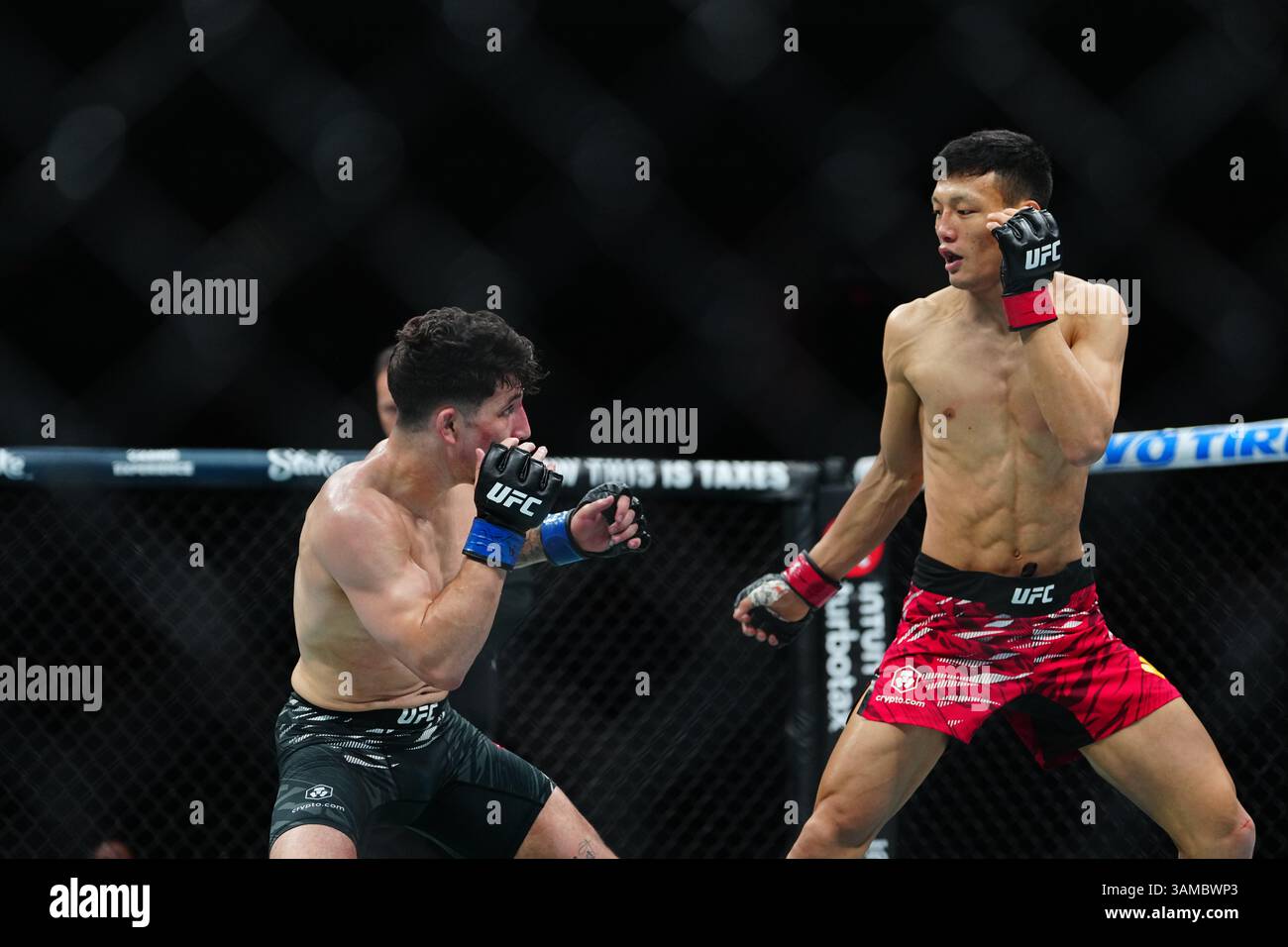 MIAMI, FL - APRIL 12:Sumudaerji and Mitch Raposo meet in the octagon ...