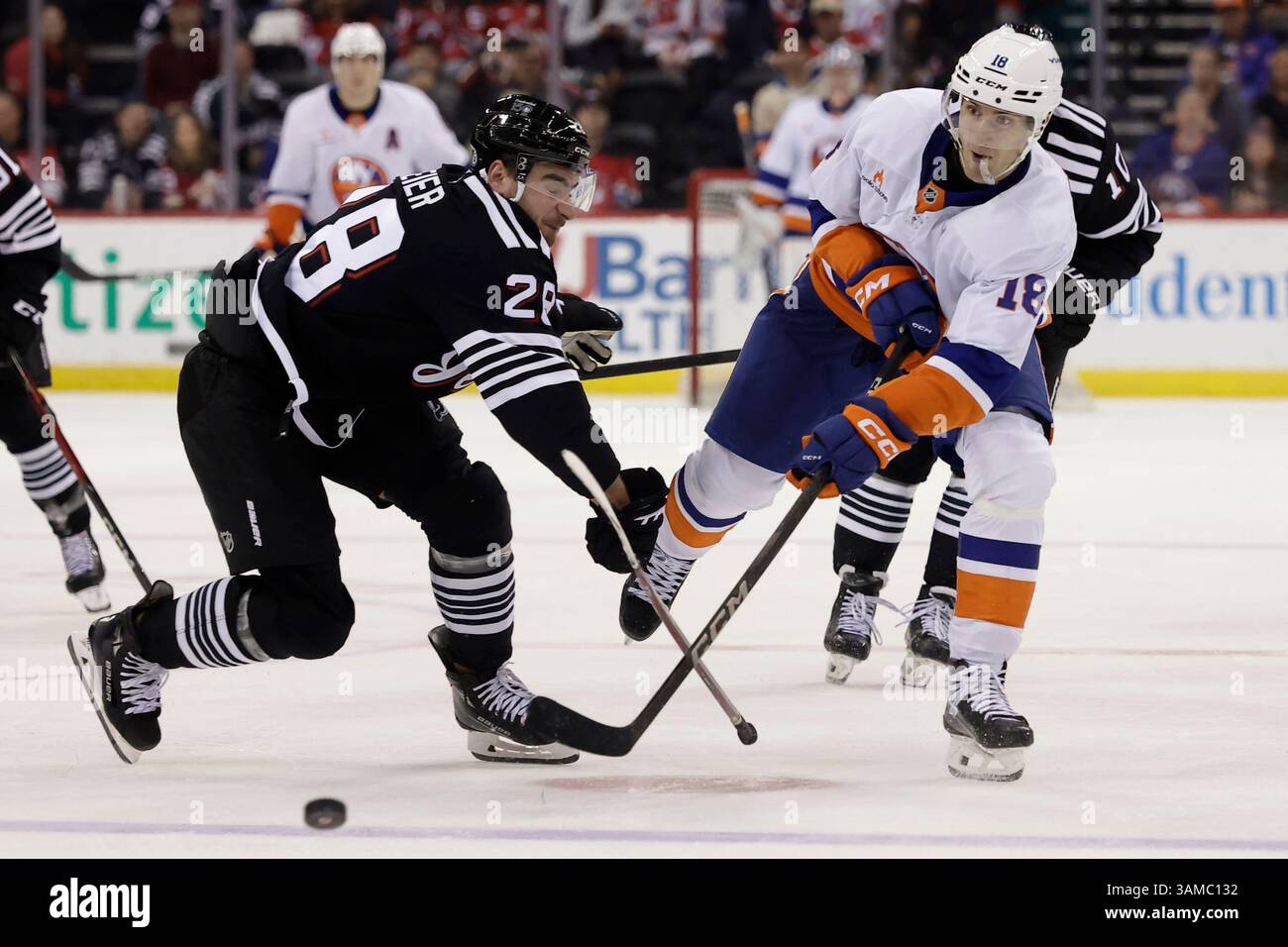 New York Islanders left wing Pierre Engvall (18) passes the puck past ...