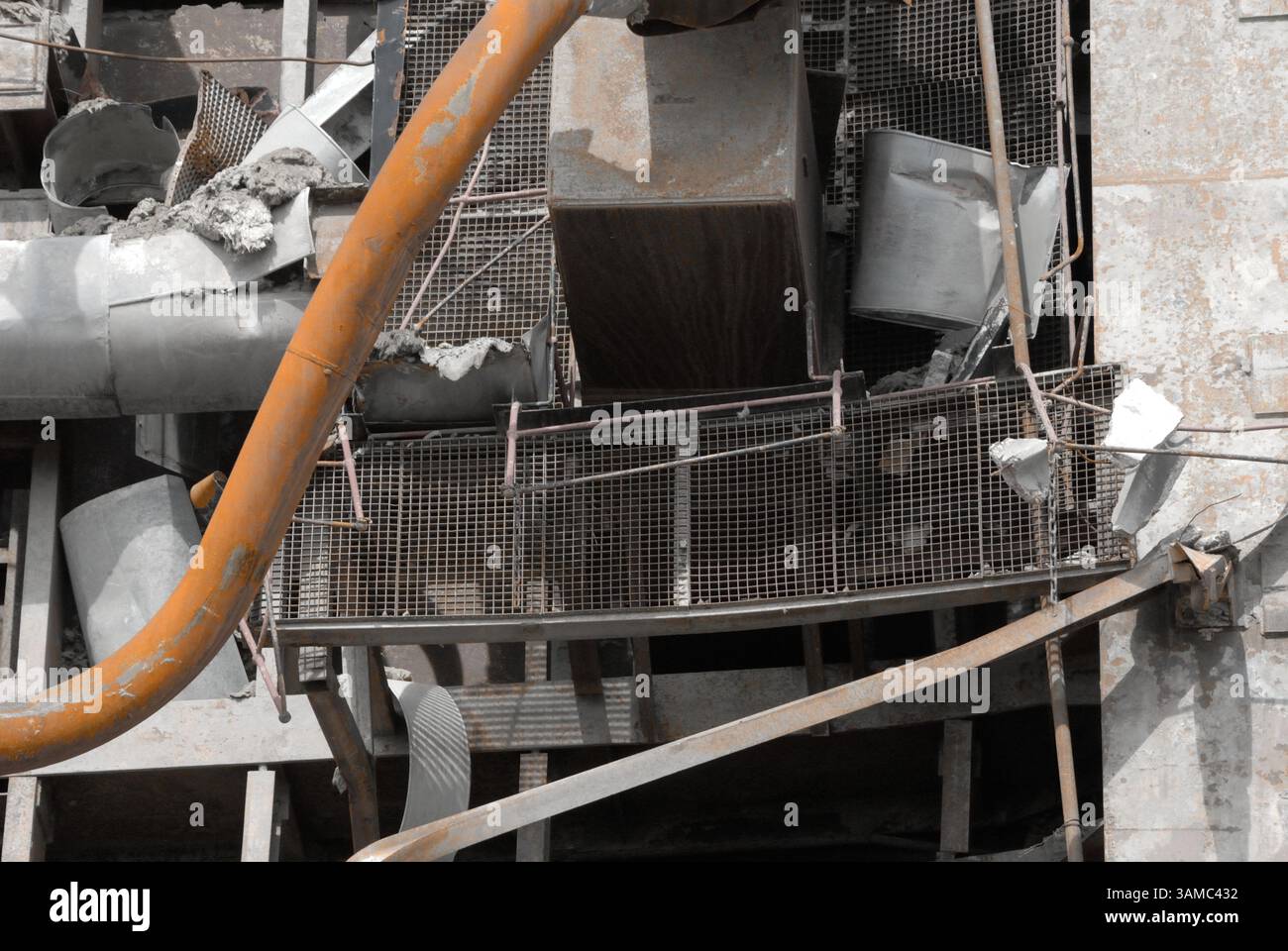 A massive building being dismantled - exposed pipes, burst walls and ...