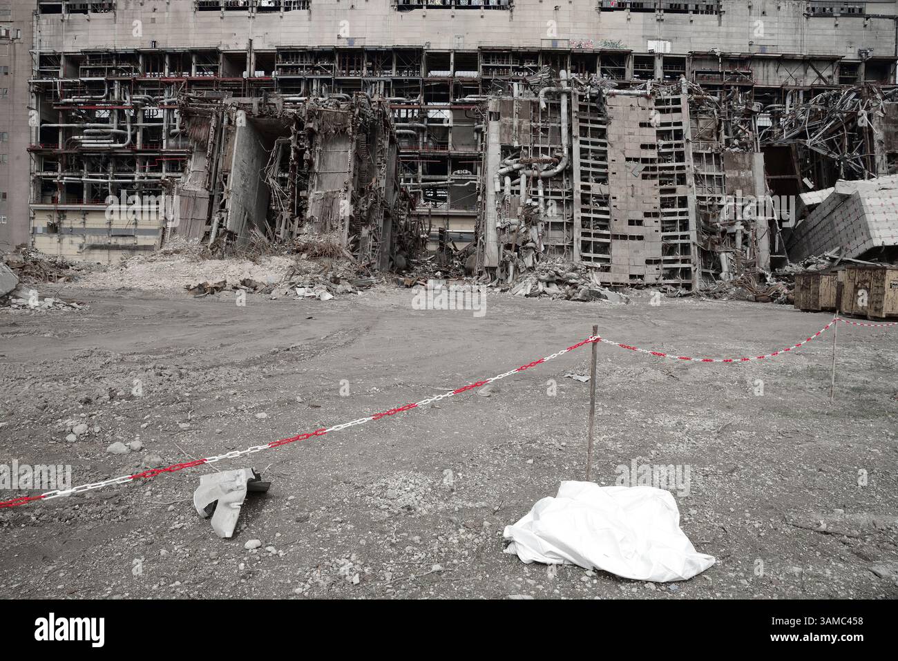 A massive building being dismantled - exposed pipes, burst walls and ...