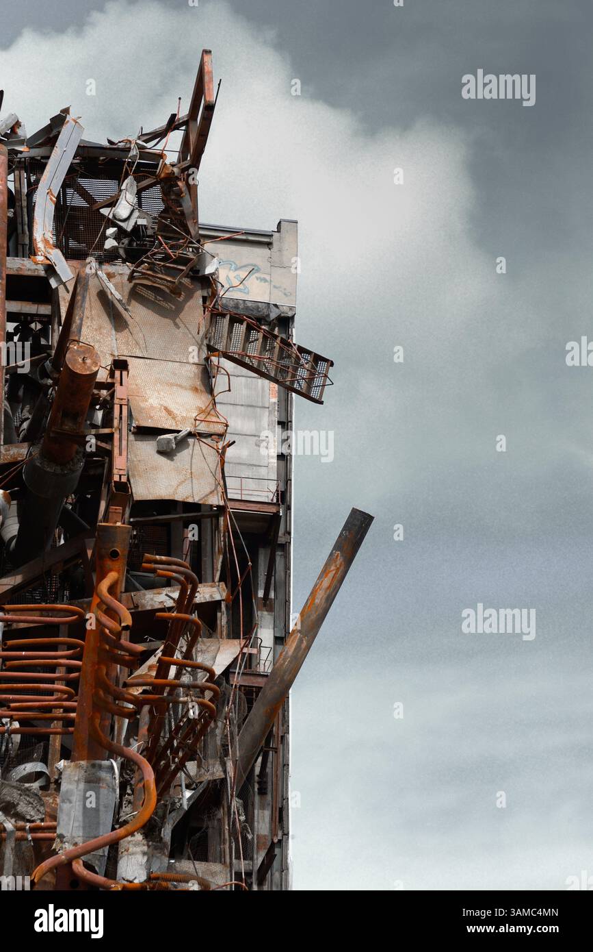 A massive building being dismantled - exposed pipes, burst walls and ...