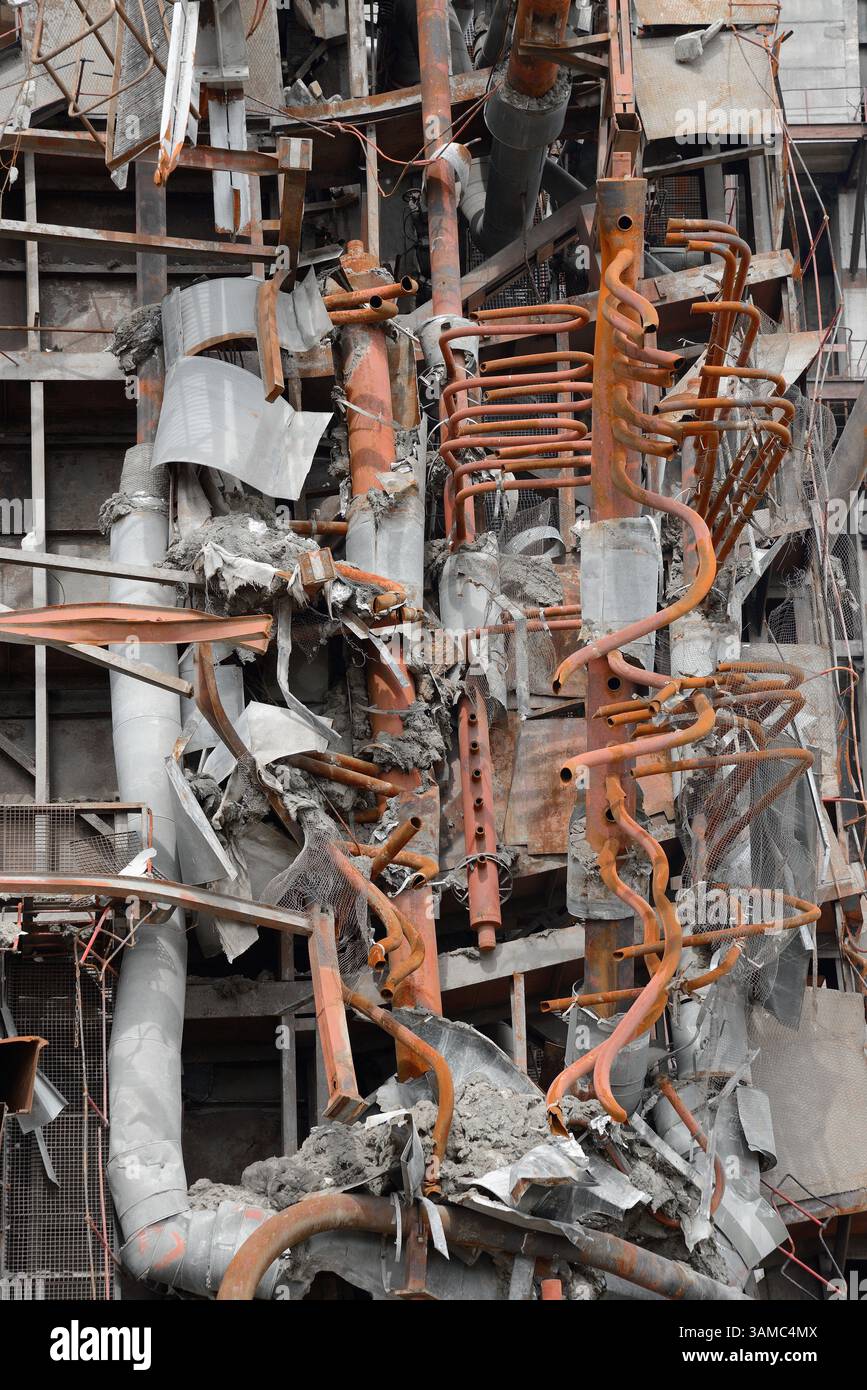 A massive building being dismantled - exposed pipes, burst walls and ...