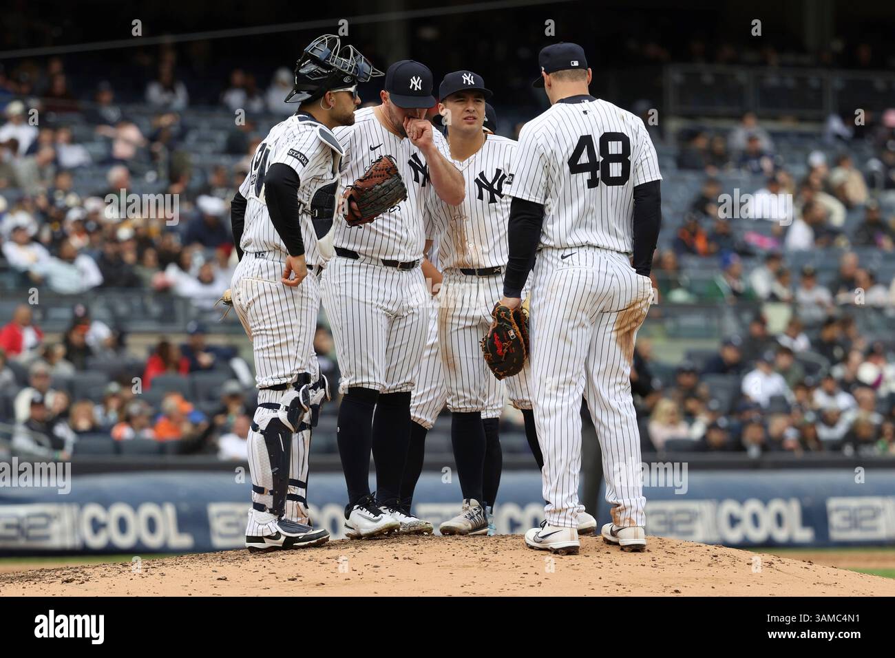 New York Yankees players talk on the pitcher's mound during the sixth ...