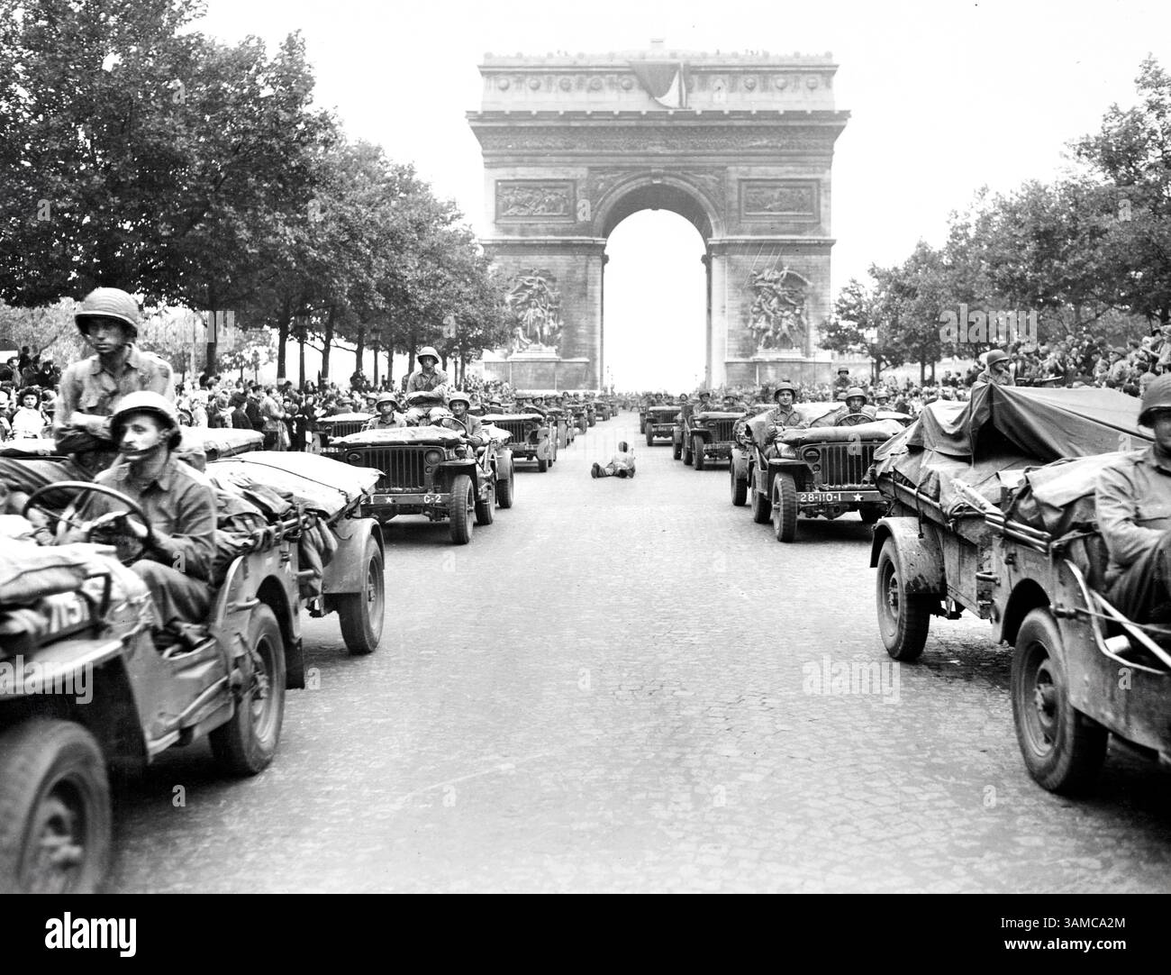 Military jeeps of American 28th Infantry Division moving down Champs ...