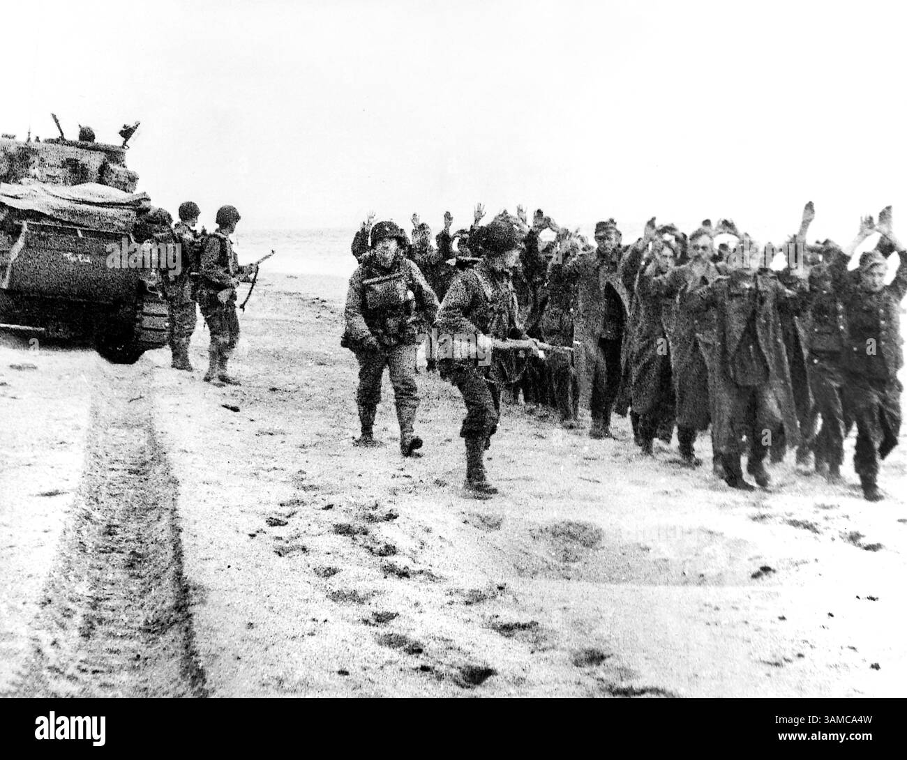American soldiers marching group of German prisoners along beachhead ...