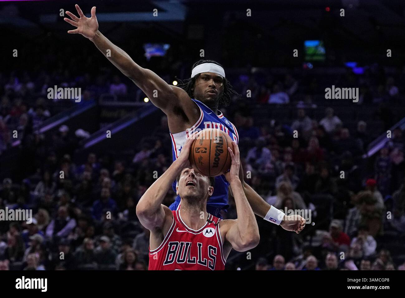 Philadelphia 76ers' Ricky Council IV, top, goes up to block a shot by ...