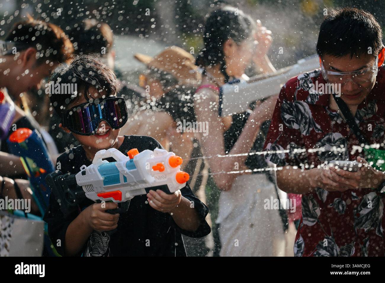 Tourists use water guns as they celebrates the Songkran holiday or ...