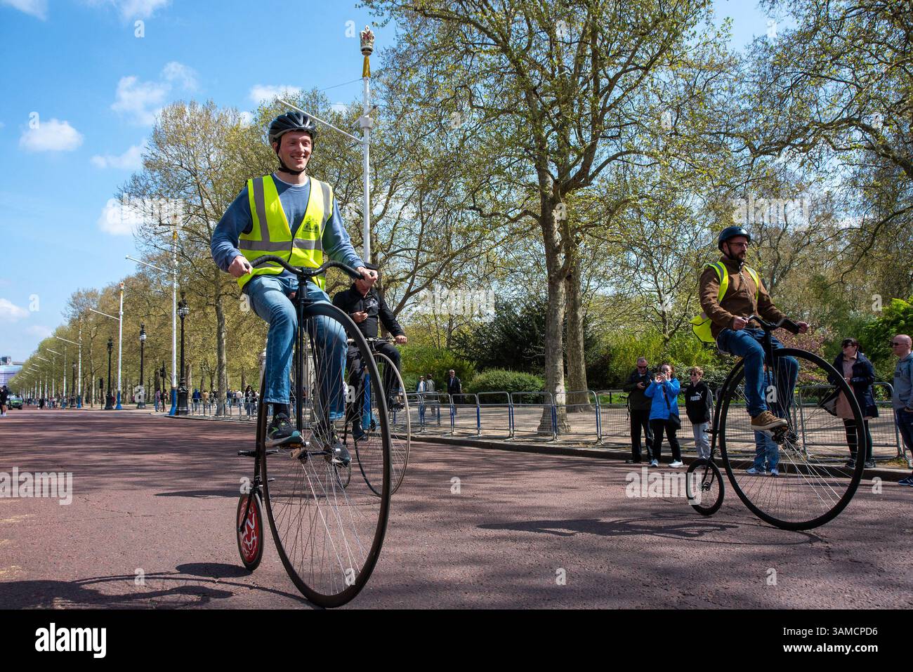 Tourists ride penny-farthings (Victorian style bikes) on the Mall. The ...