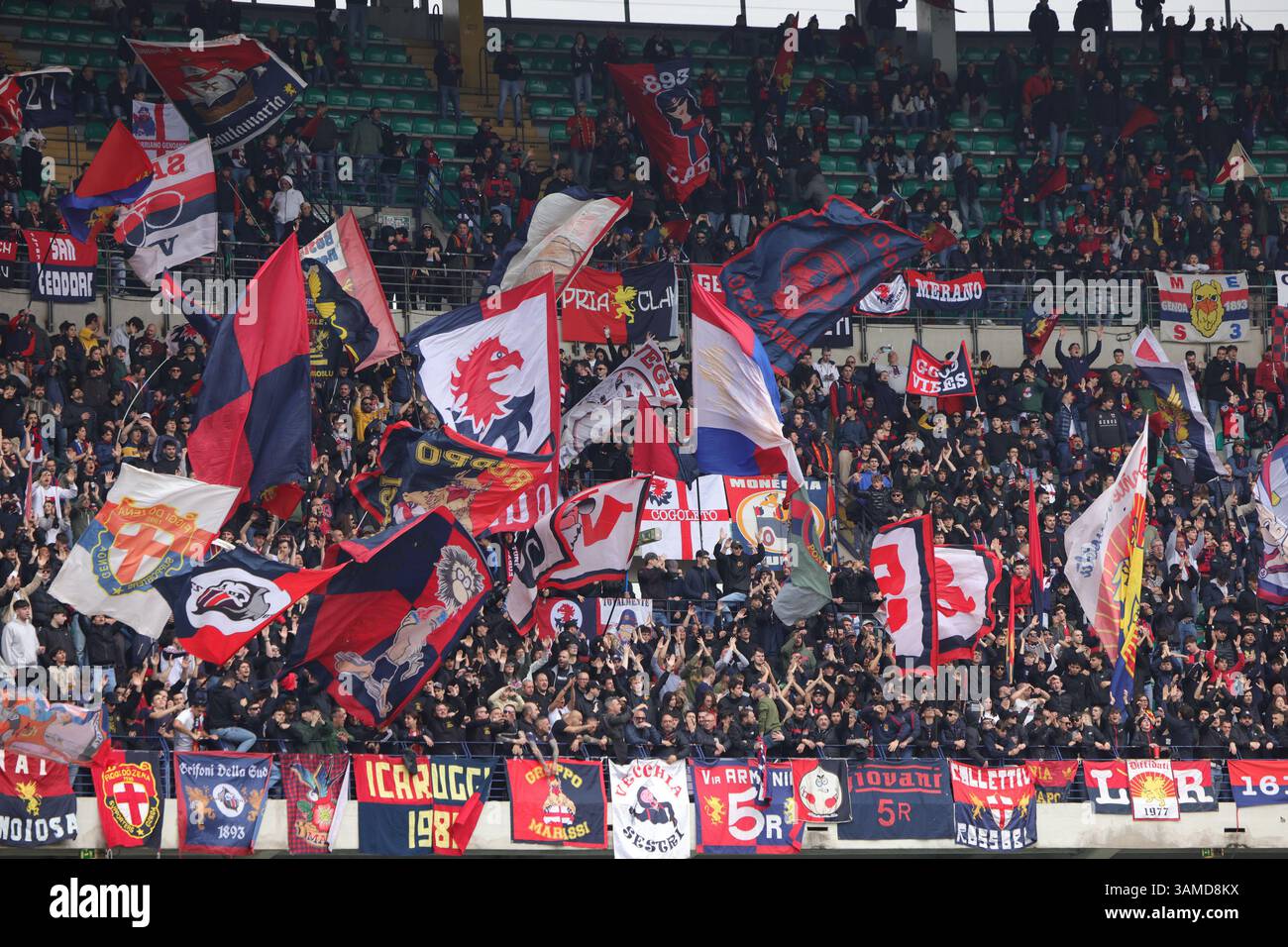 Verona, Italy. 13th Apr, 2025. Genoa CFC's fans wave flags before kick ...