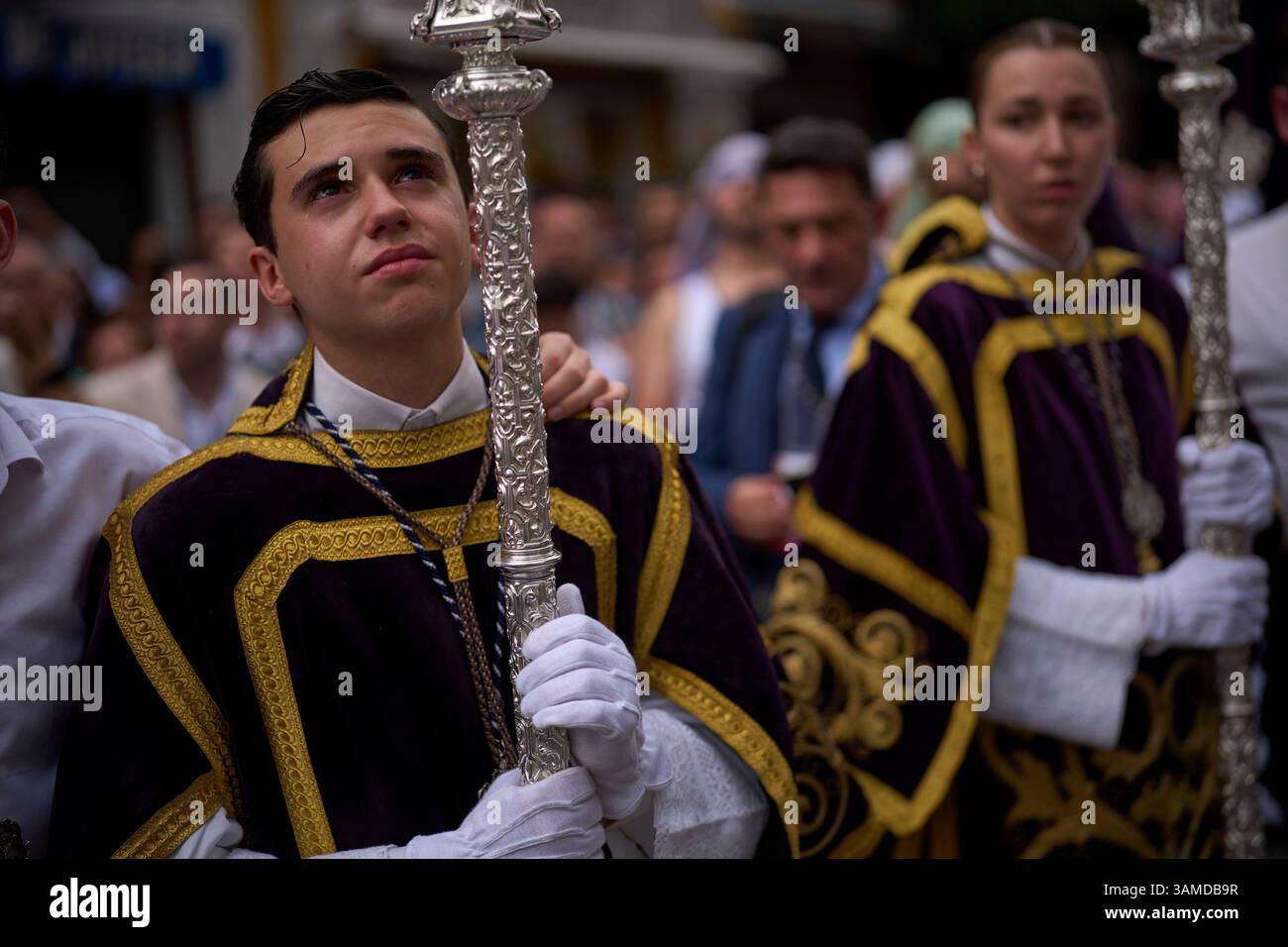 An altar boy from the brotherhood of La Estrella reacts by crying while ...