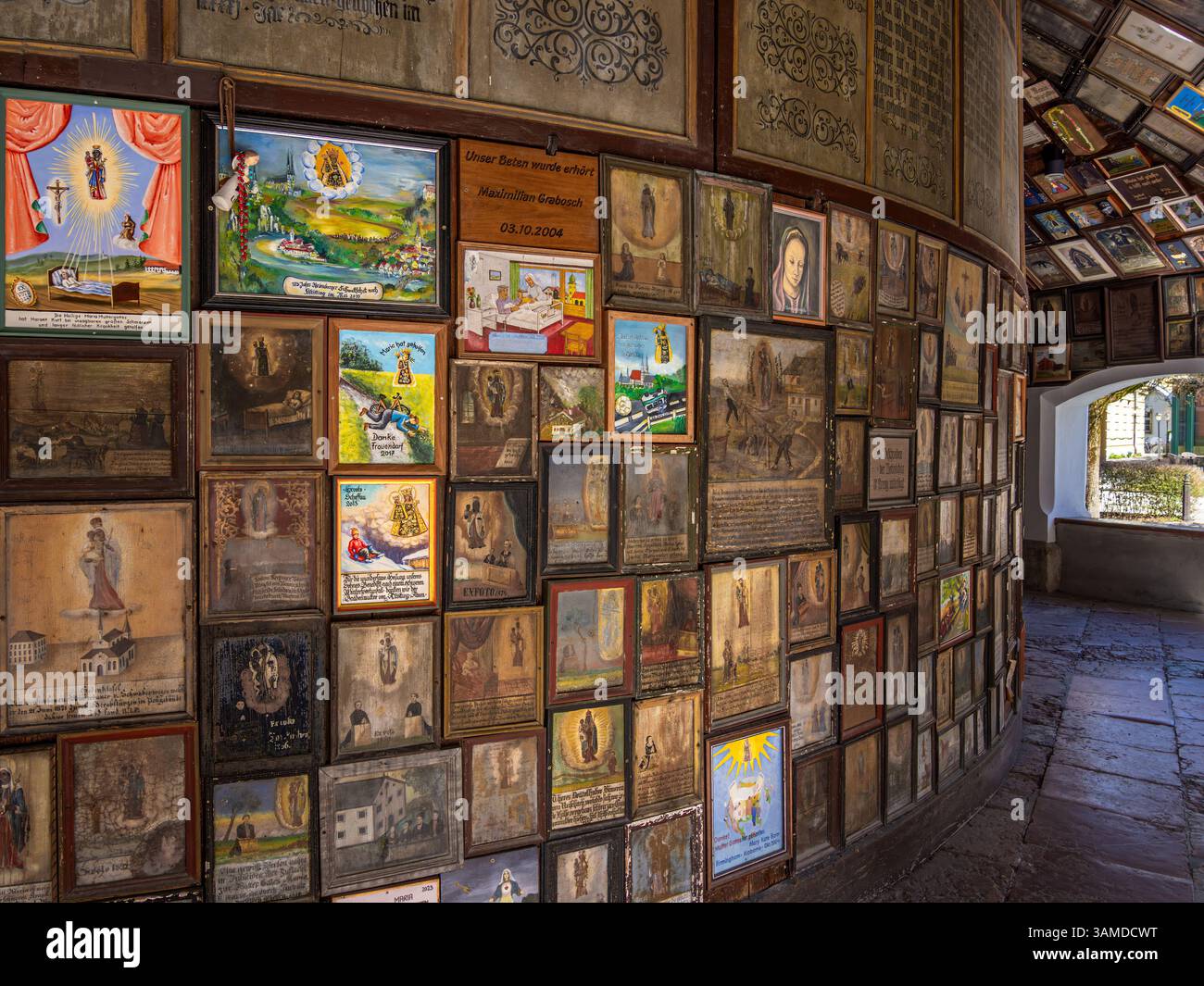 Altotting, Germany - March 19, 2025: Votive paintings in the ambulatory ...