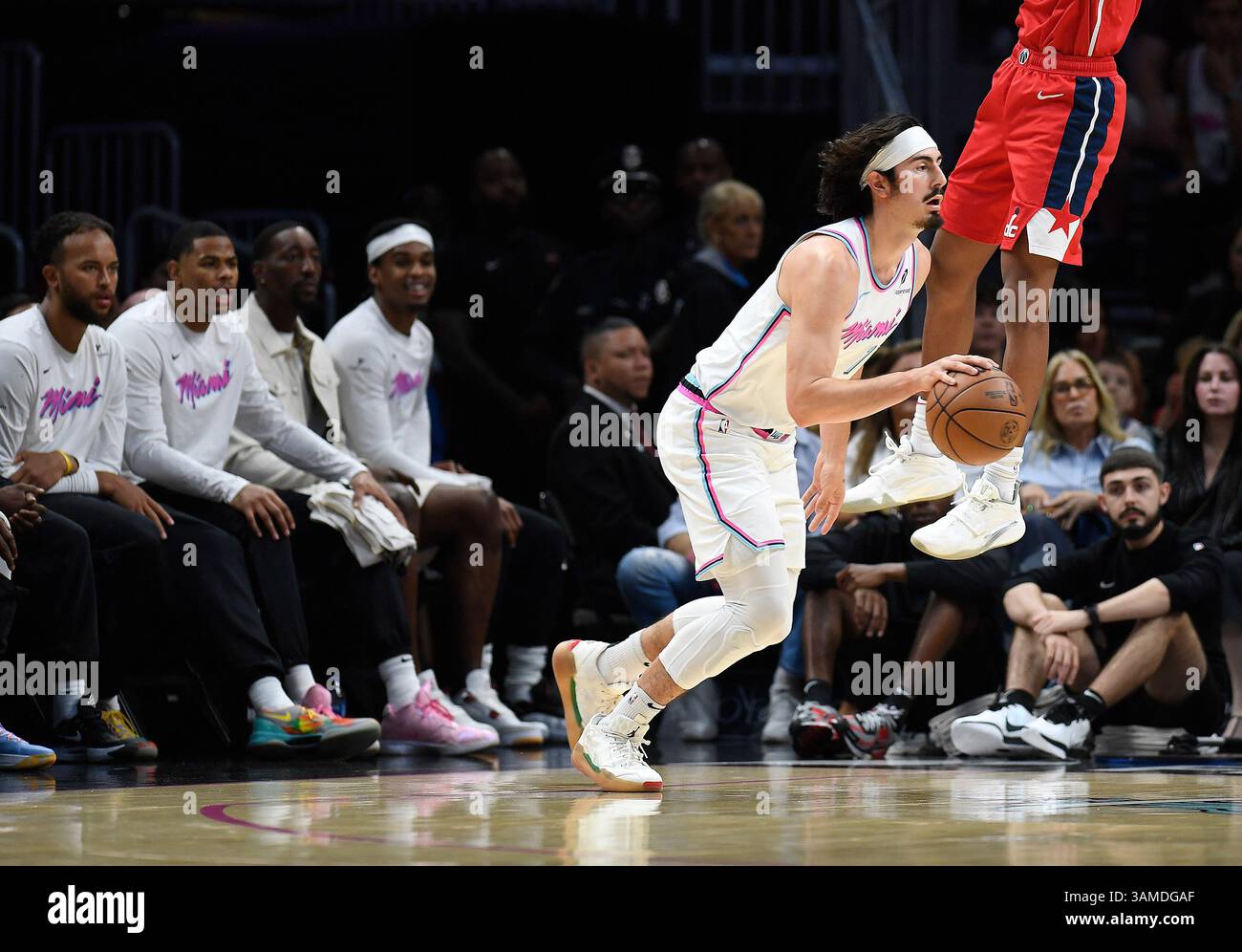 Miami Heat guard Jaime Jaquez Jr. (11) drives past Washington Wizards forward Justin Champagnie ...