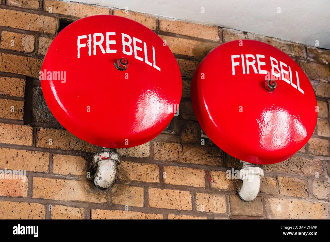 Vintage red fire alarm bells installed in brick wall, fire alarm system ...