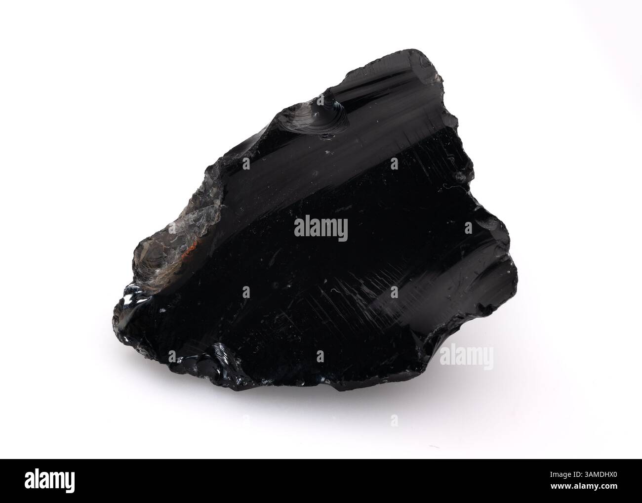 Rough black obsidian rock with glossy surface and internal texture on ...