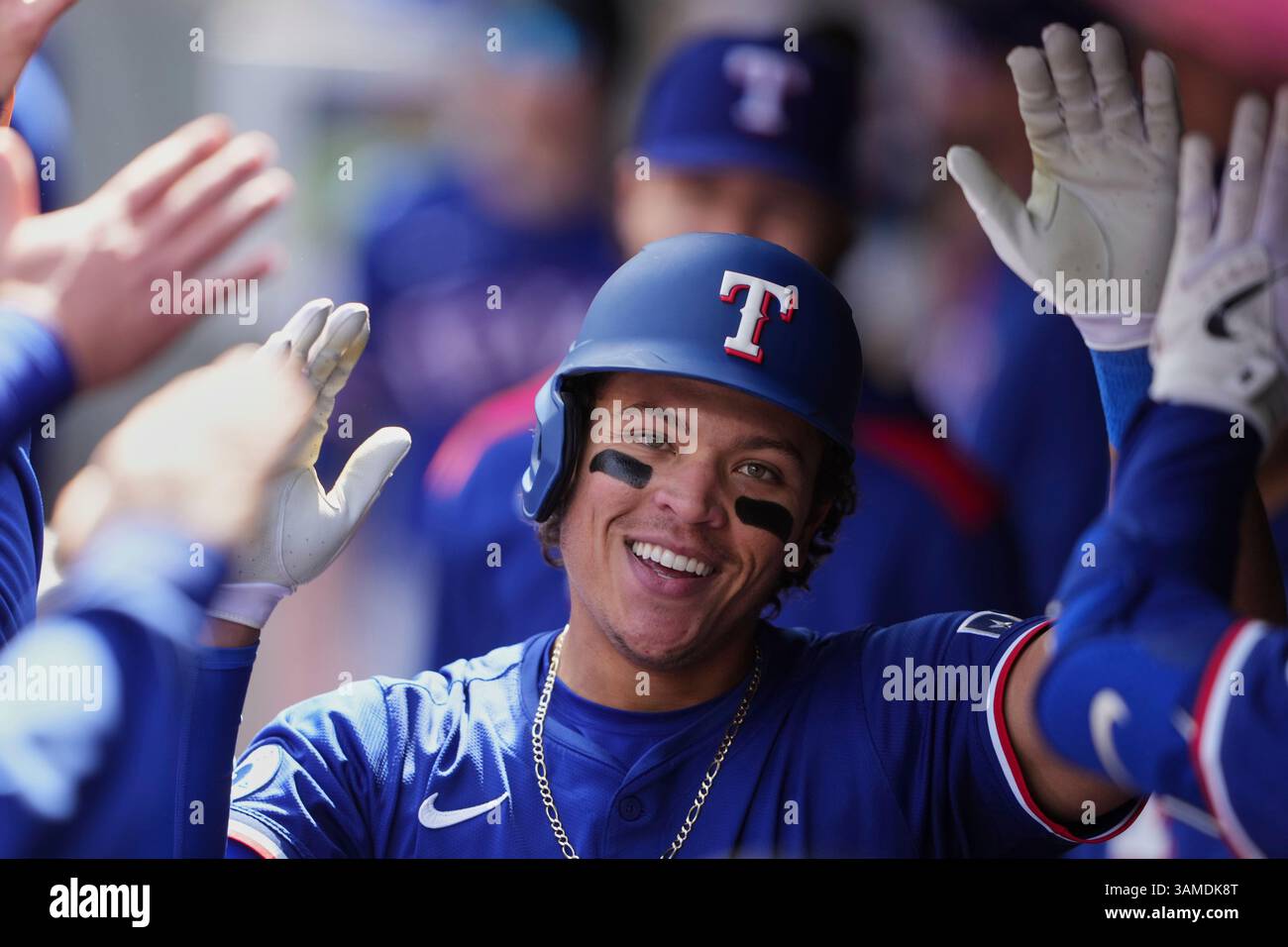 Texas Rangers' Dustin Harris is greeted in the dugout after hitting a ...