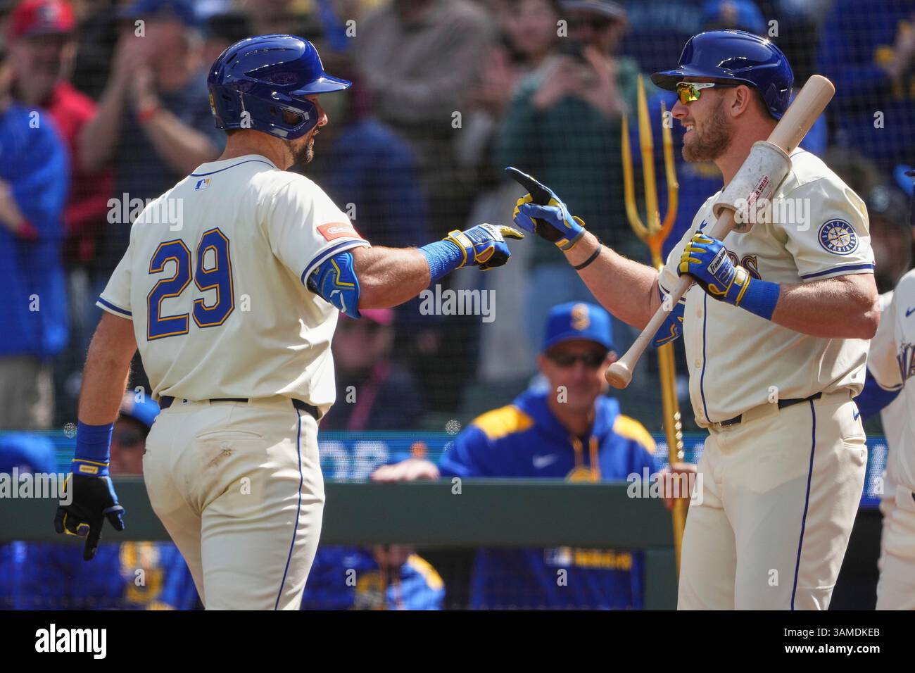Seattle Mariners' Cal Raleigh (29) greets Luke Raley, right, after ...
