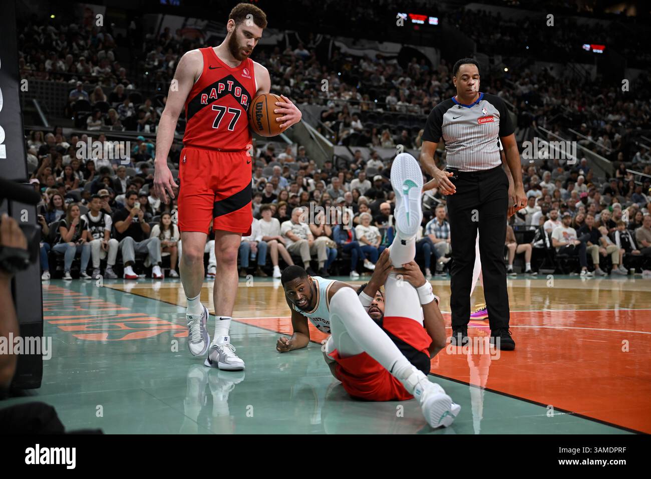 Toronto Raptors forward Garrett Temple holds his knee after colliding ...