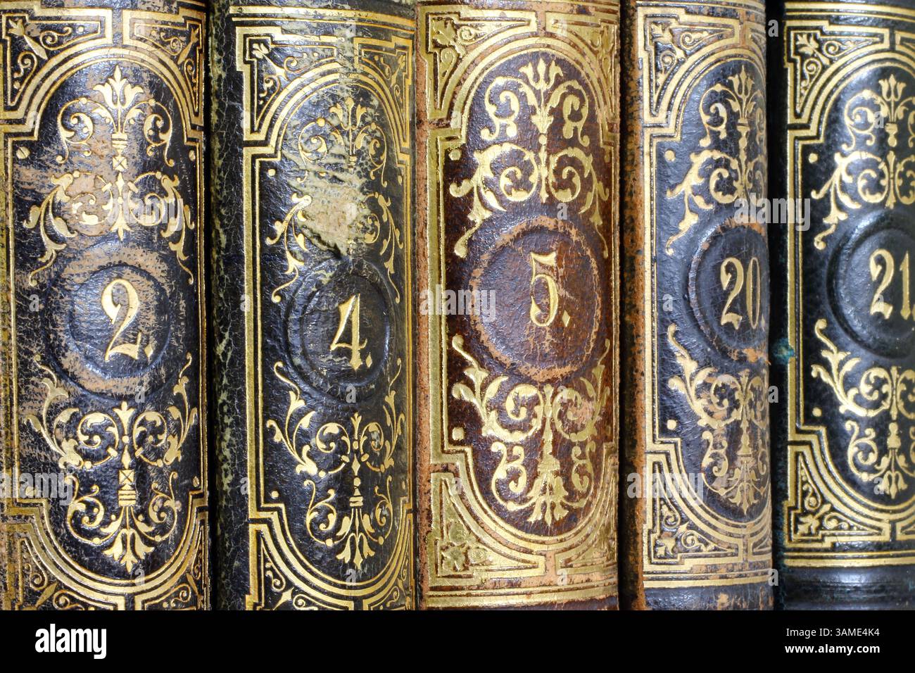 Vintage ornate book spines with intricate gold designs and numbers ...