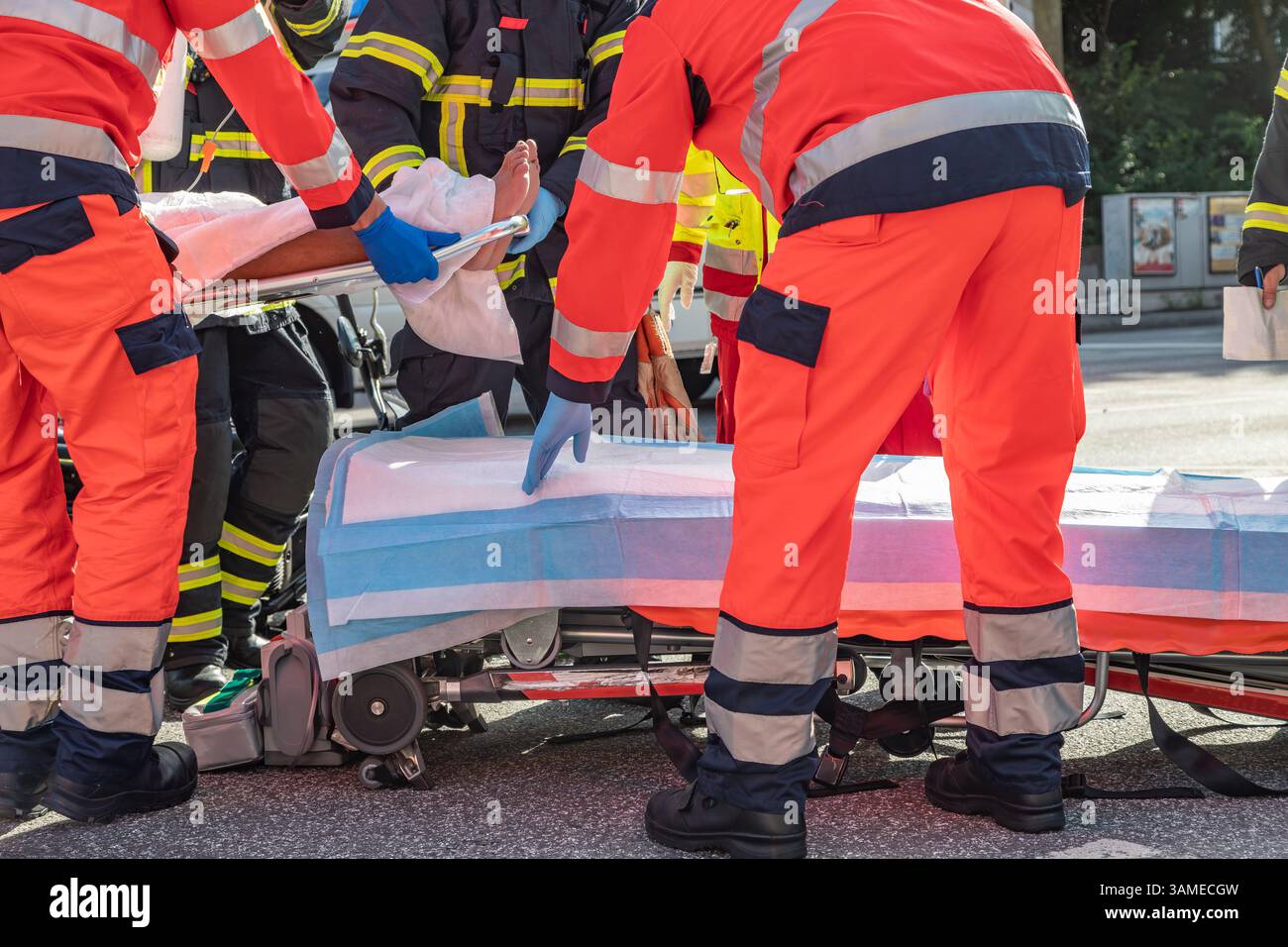 Rescue workers place victim on rescue stretcher Stock Photo - Alamy