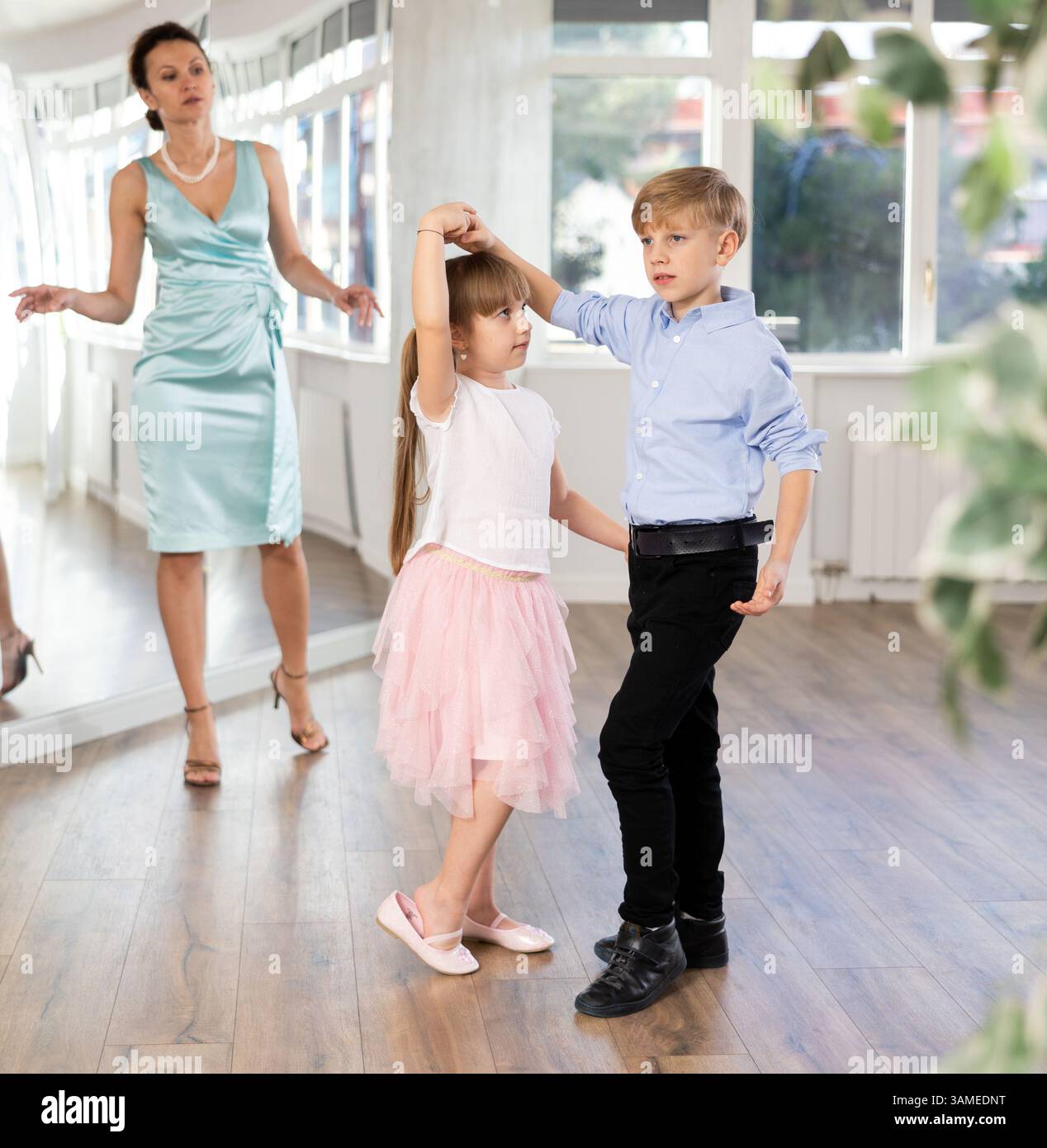 Tween girl and boy rehearsing rumba as couple in dance studio Stock ...