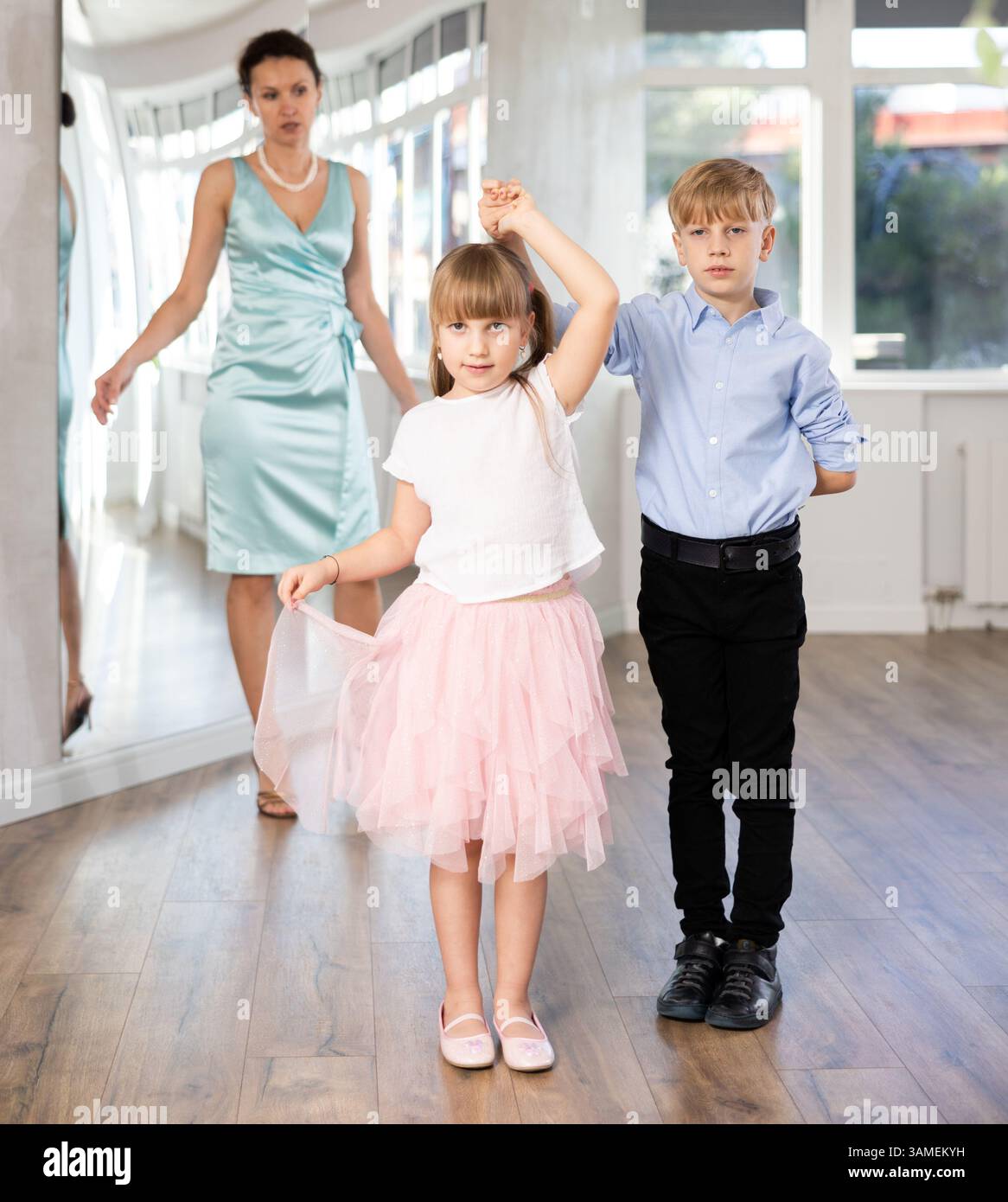 Tween boy and girl performing waltz in pair in dance hall Stock Photo ...