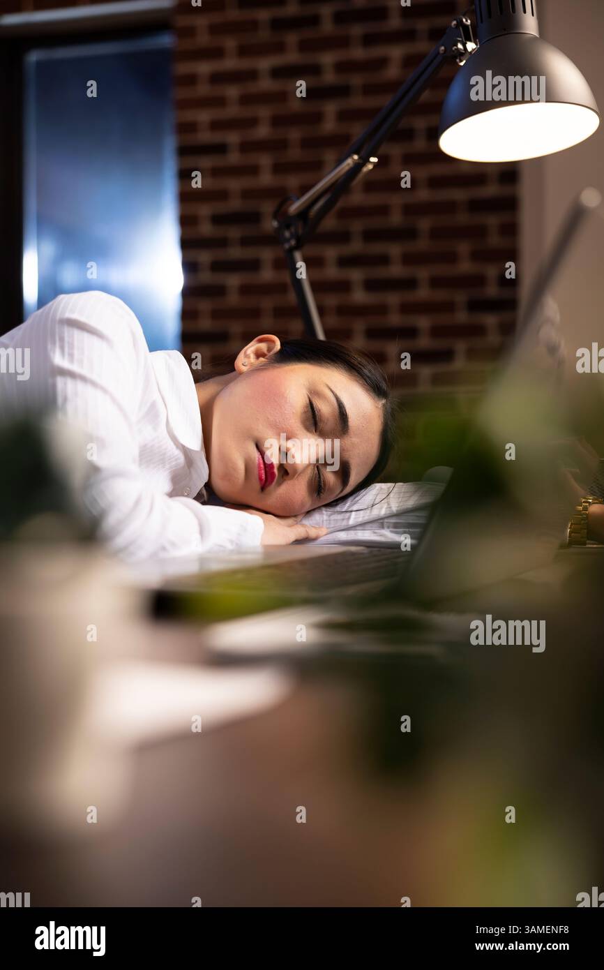 Tired woman manager falls asleep beside her open laptop, taking a ...