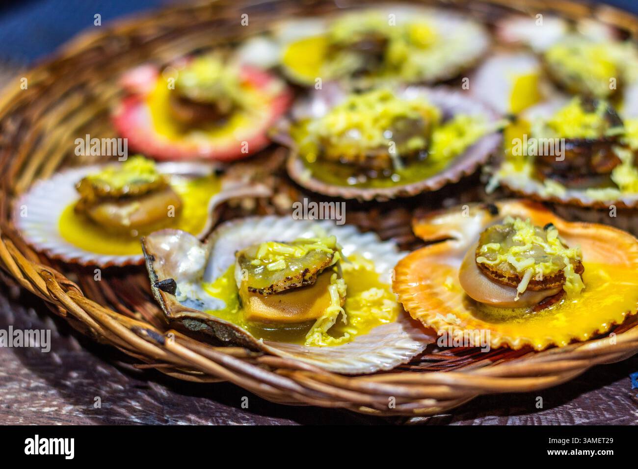 Steamed scallop shells topped with melted cheese, a popular seafood ...