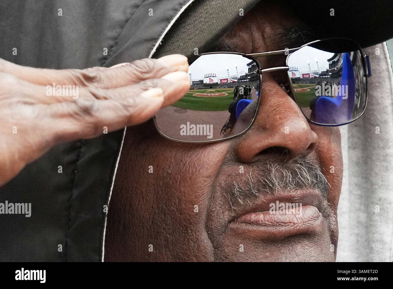 A White Sox security guard salutes during the National Anthem before a ...