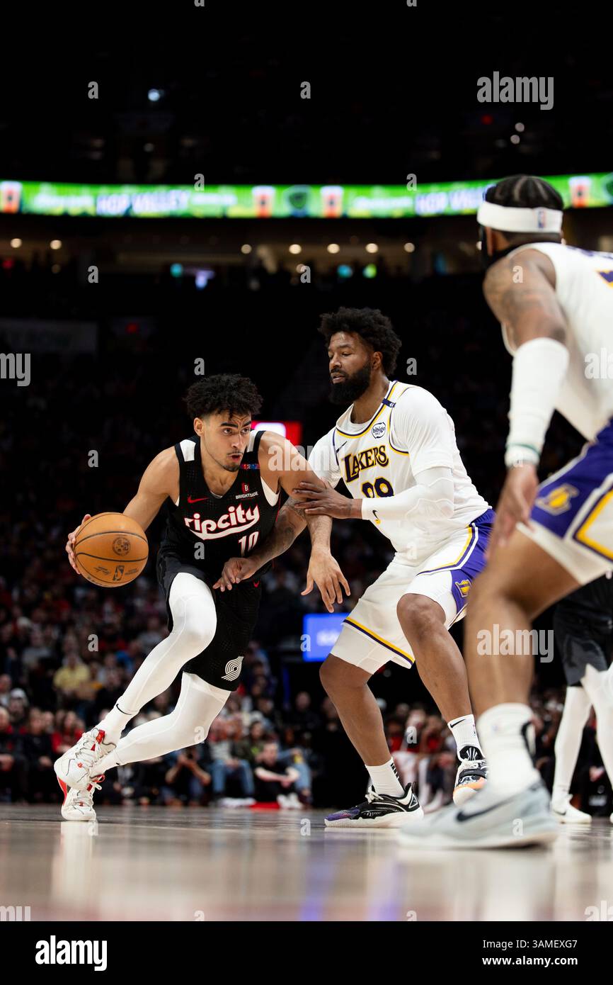 Portland Trail Blazers forward Justin Minaya, left, dribbles the ball ...