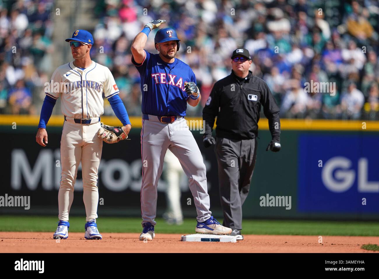 Texas Rangers' Jake Burger, center, reacts to hitting a double as ...