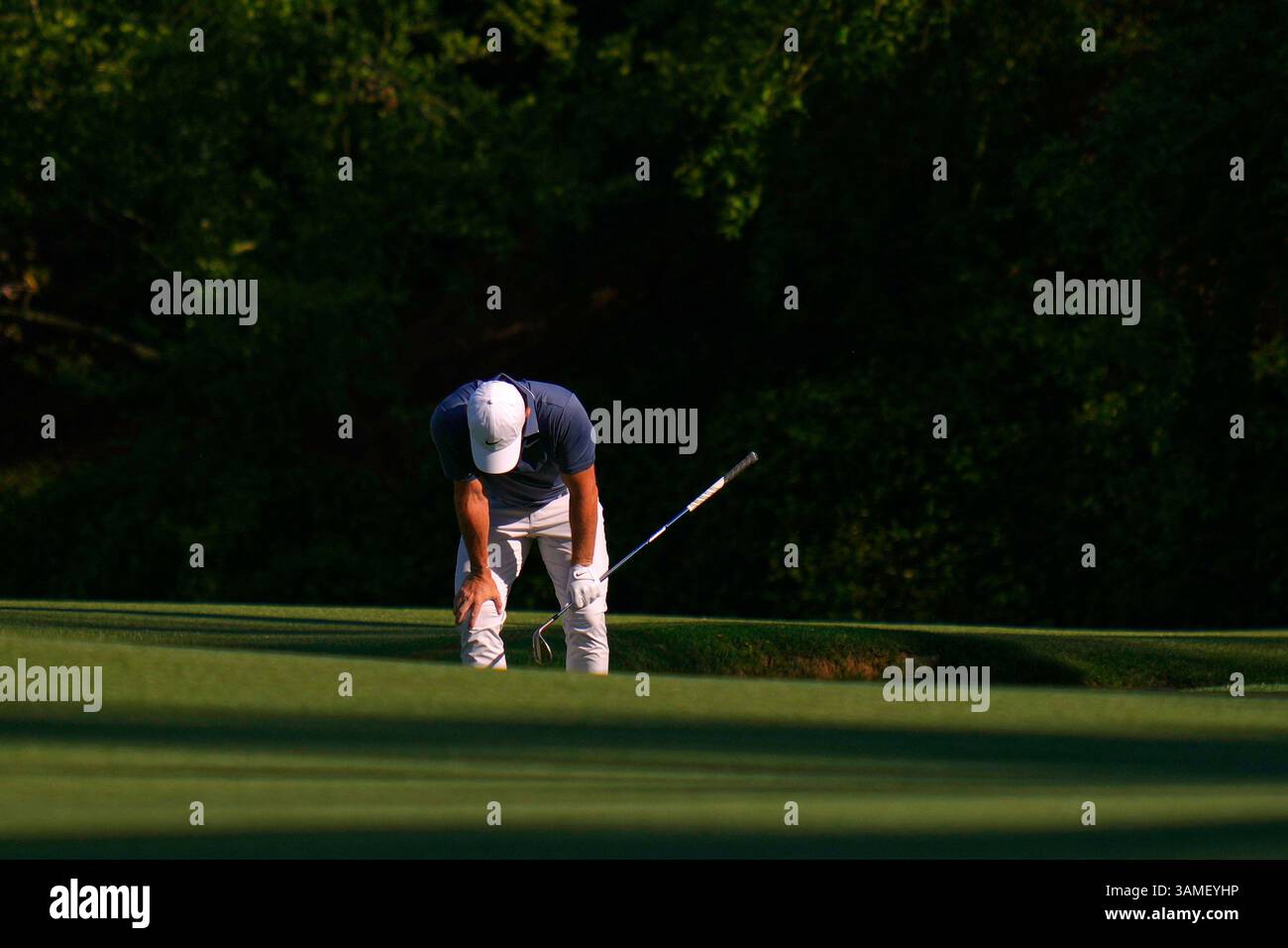 Rory McIlroy, of Northern Ireland, reacts after hitting into the water ...