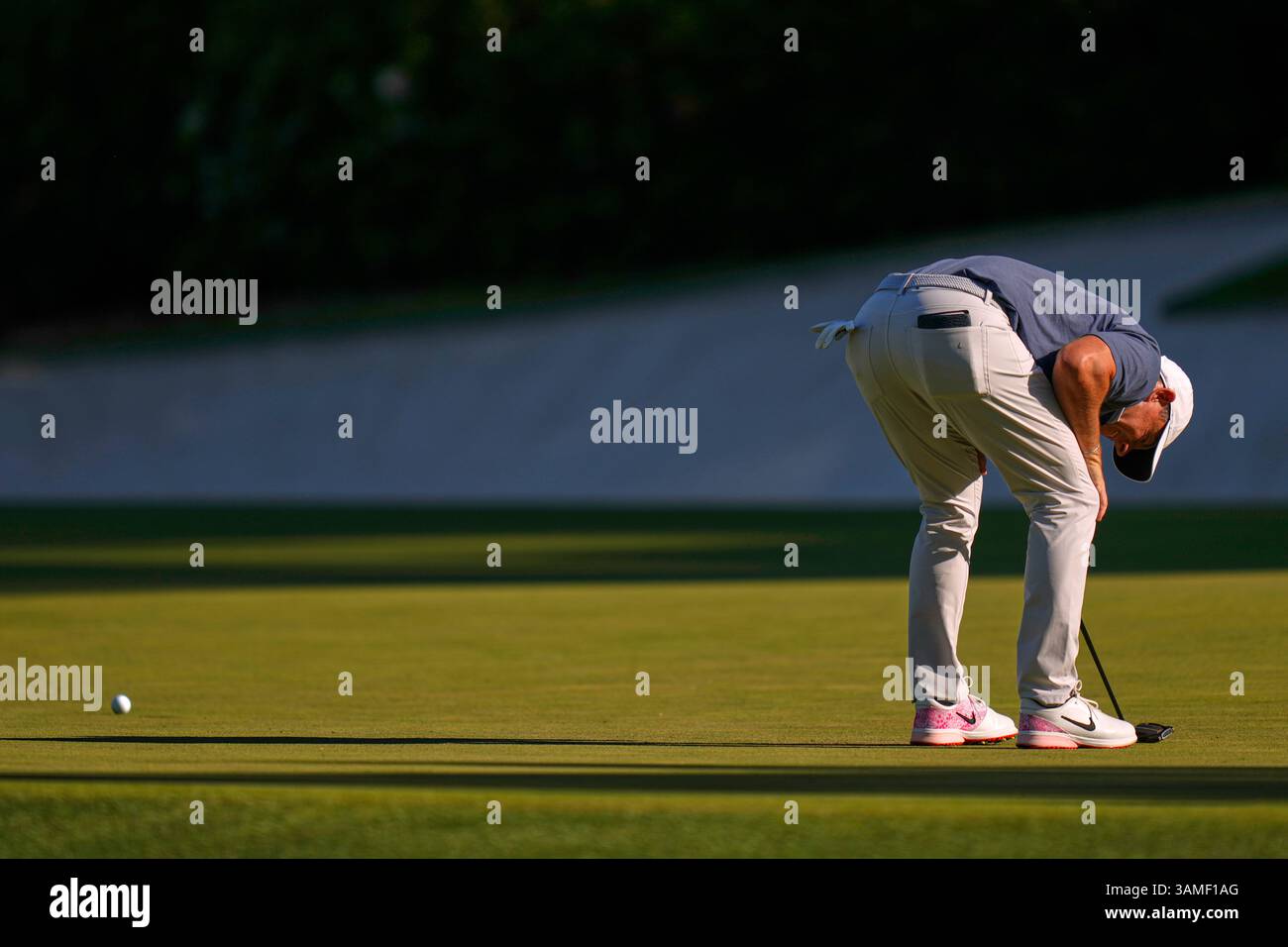 Rory McIlroy, of Northern Ireland, reacts after missing a putt on the ...