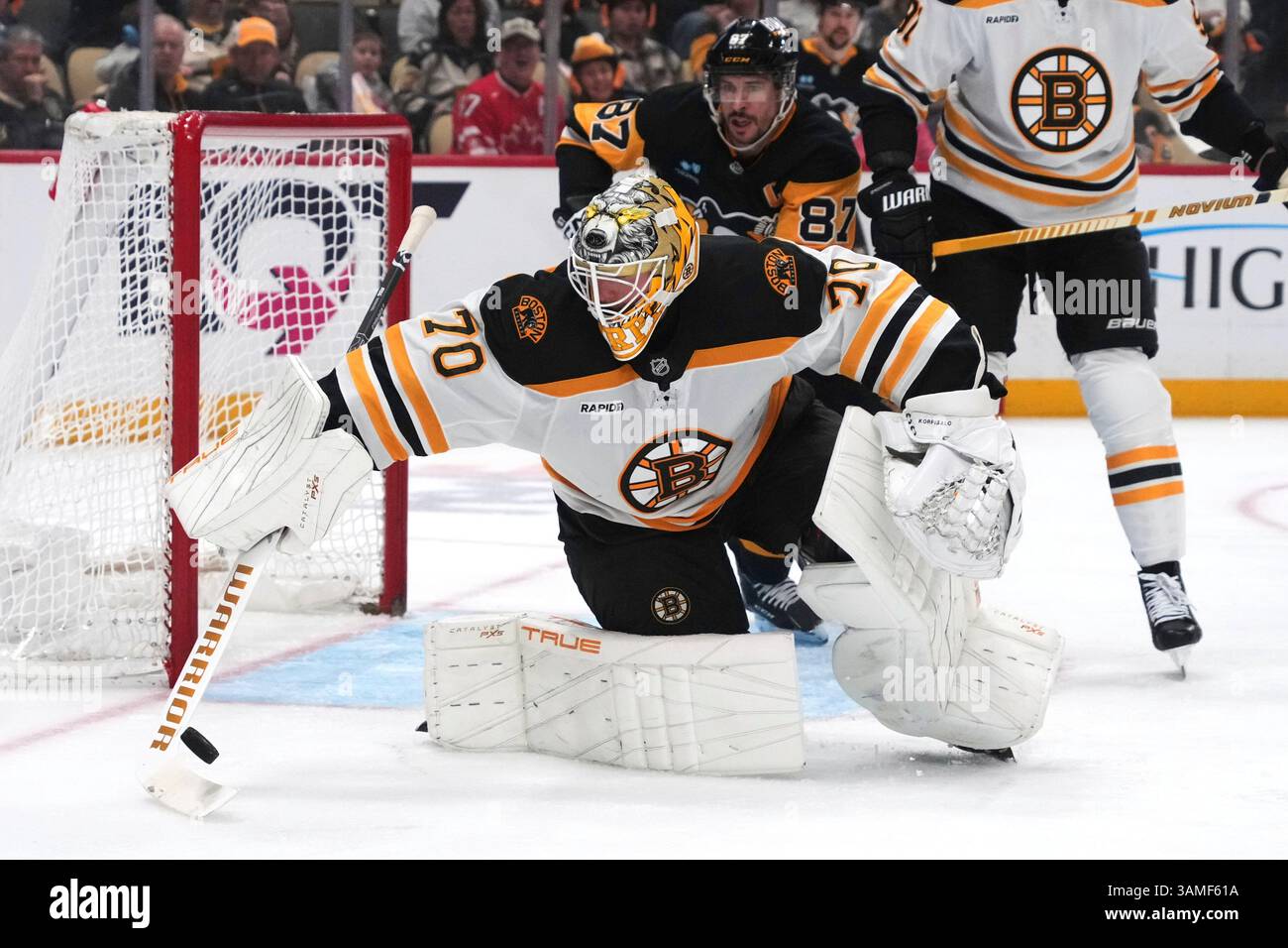 Boston Bruins goaltender Joonas Korpisalo (70) tries to control a ...